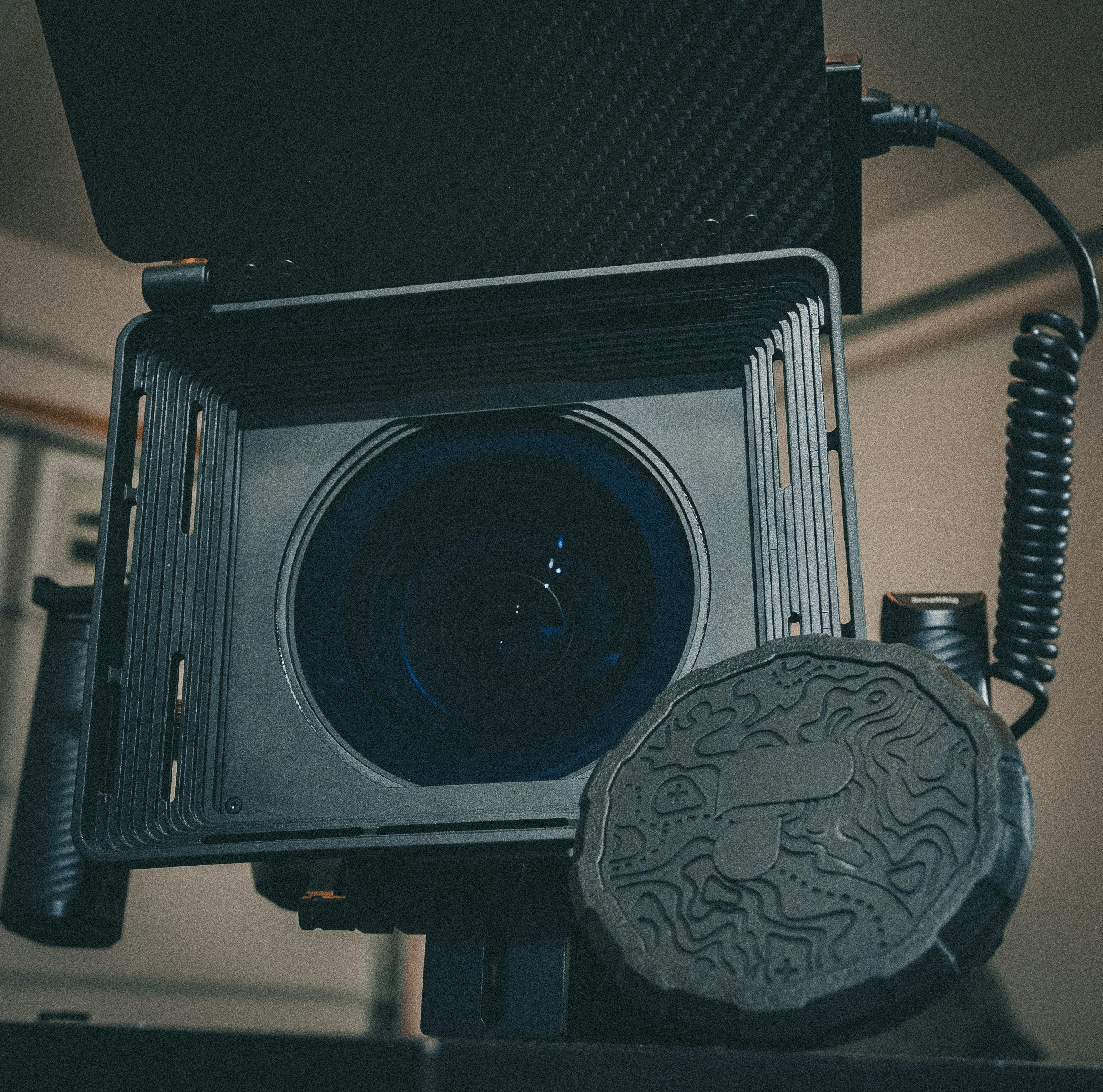 A vintage cinema lens sits in front of a camera—static focus, modern curiosity