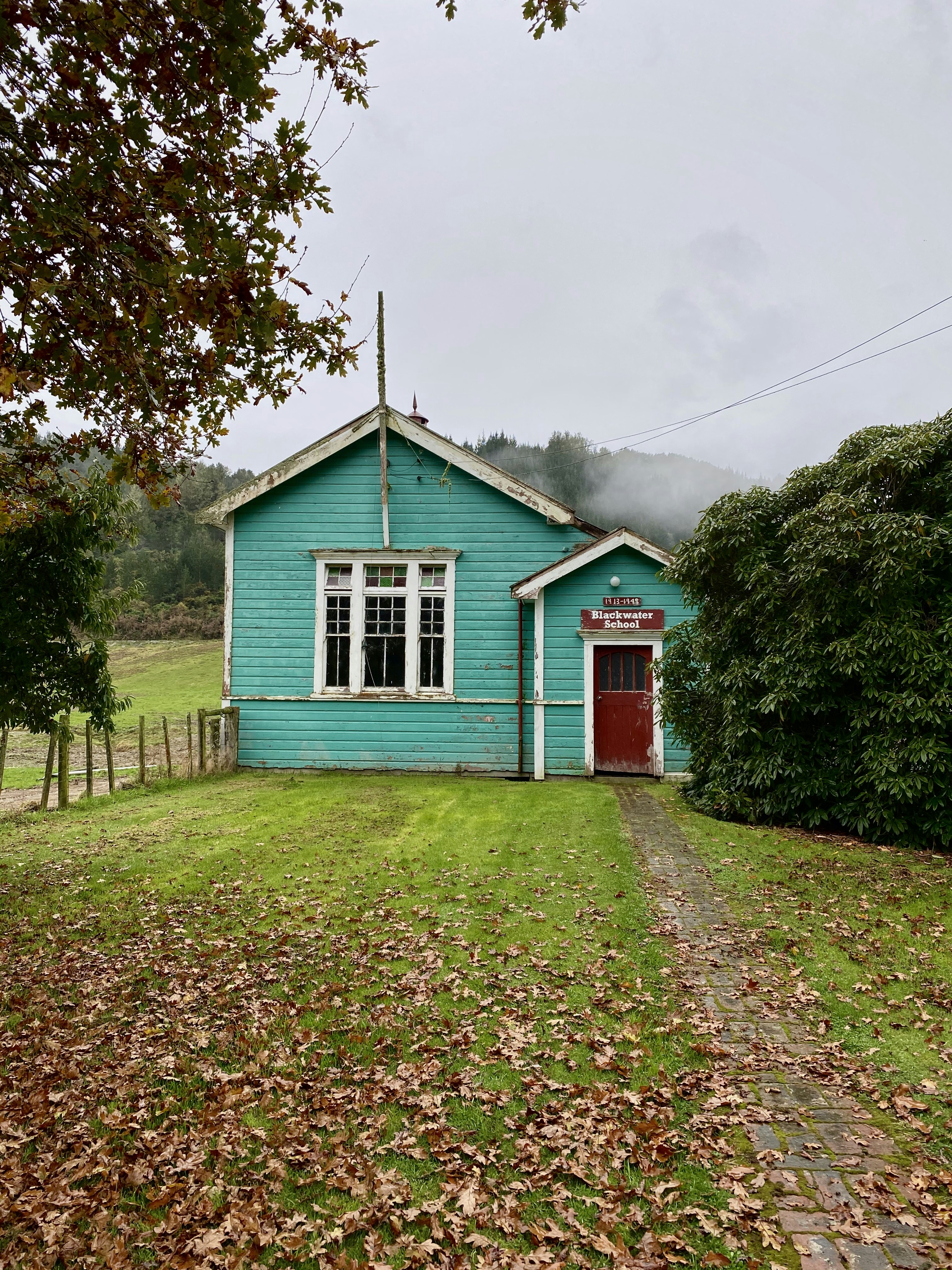 White and red wooden house near green trees under white clouds during ...