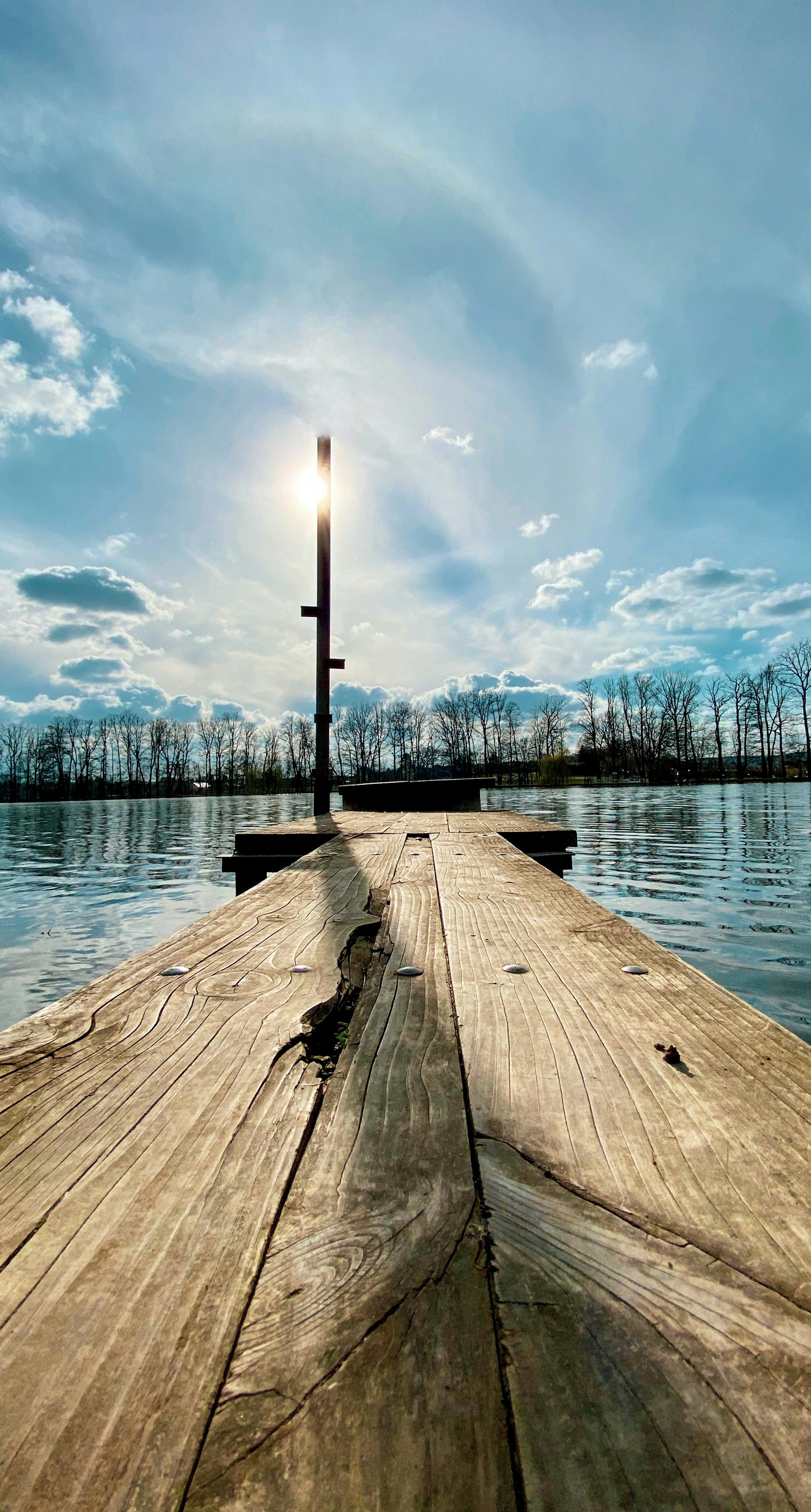 Worn Dock to the Horizon: Sunlight Pushing Through a Pier