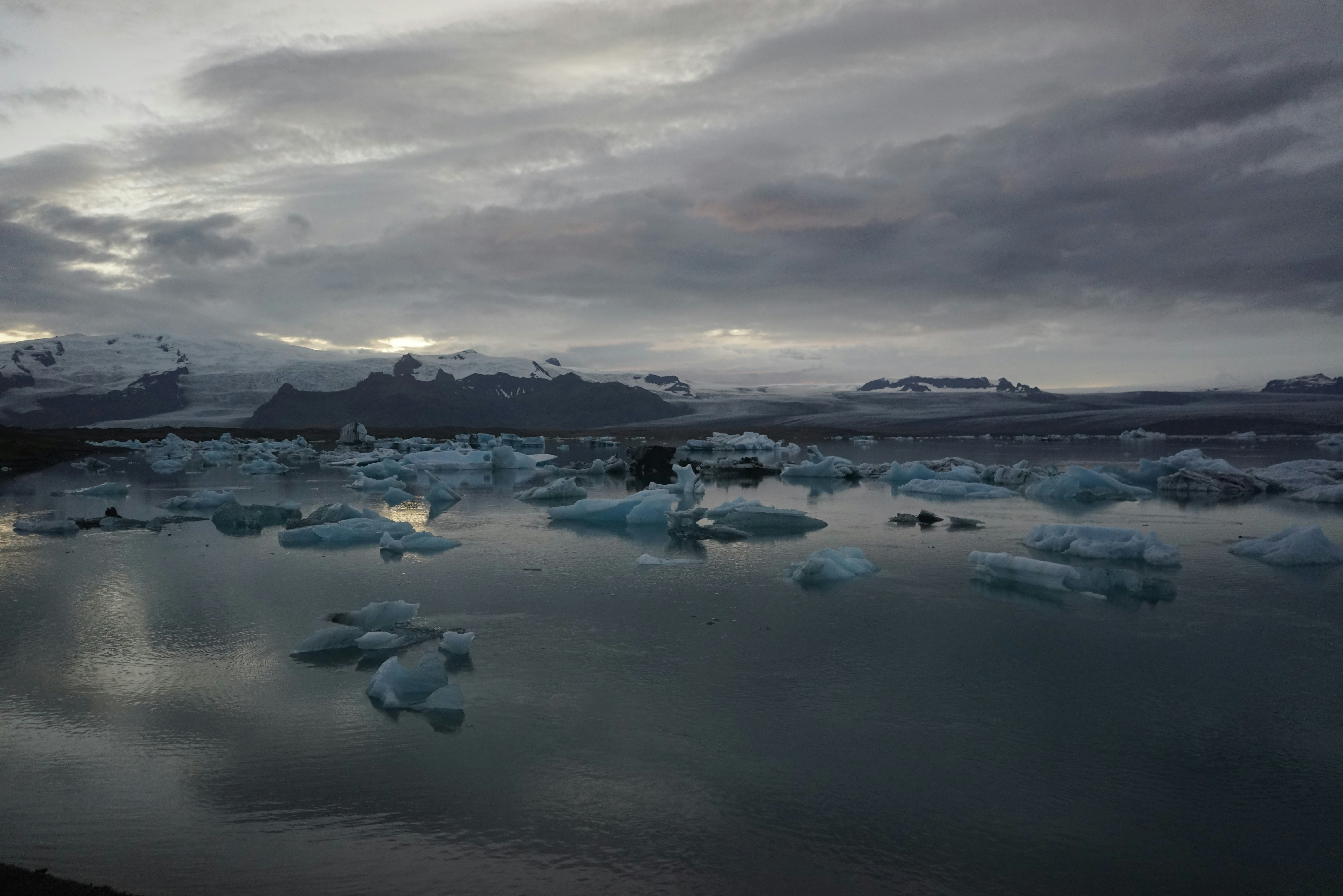Ice blocks on water under cloudy sky photo – Free Grey Image on Unsplash