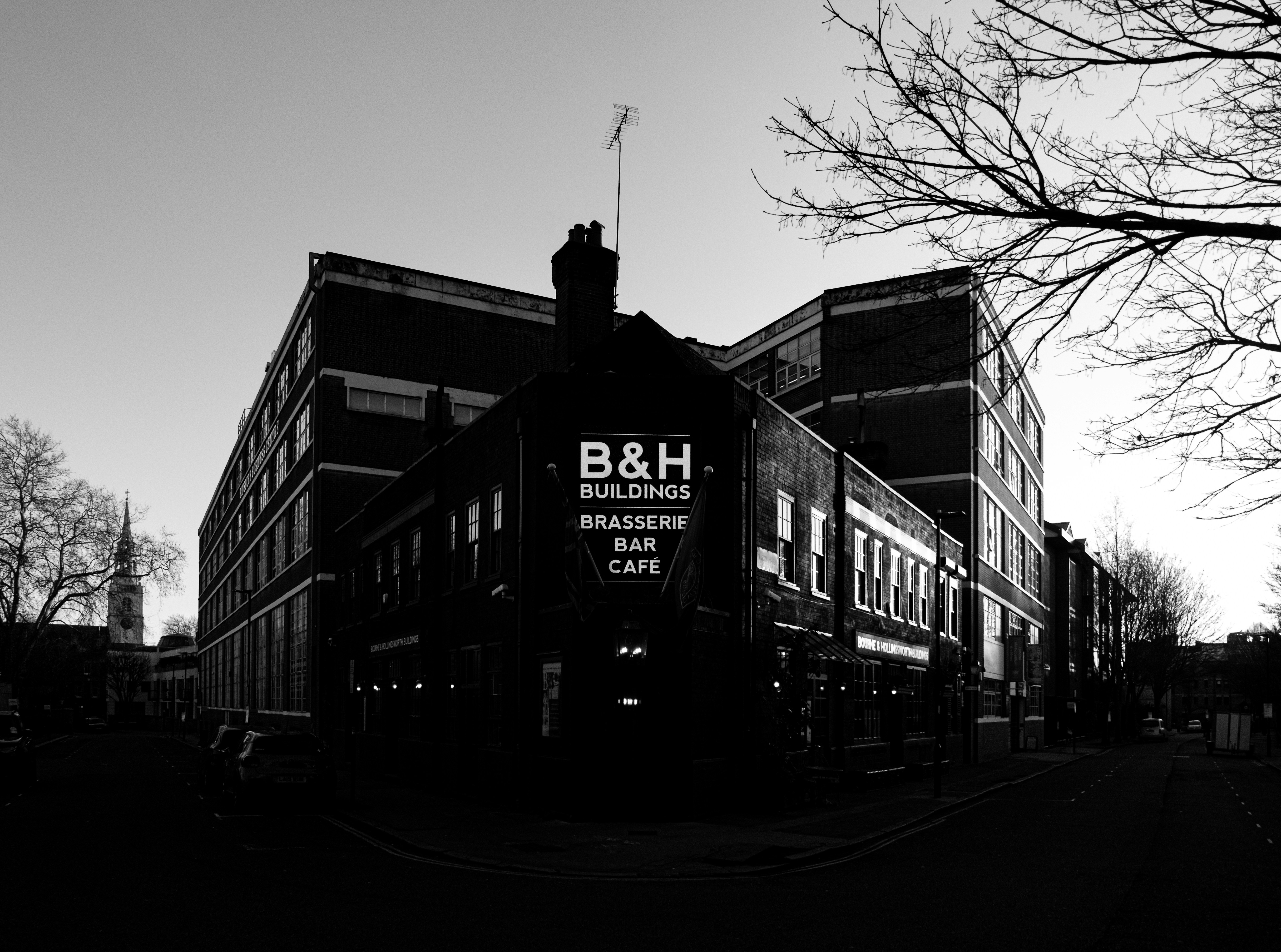 Bourne & Hollingsworth Buildings | a black and white photo of a b & h building