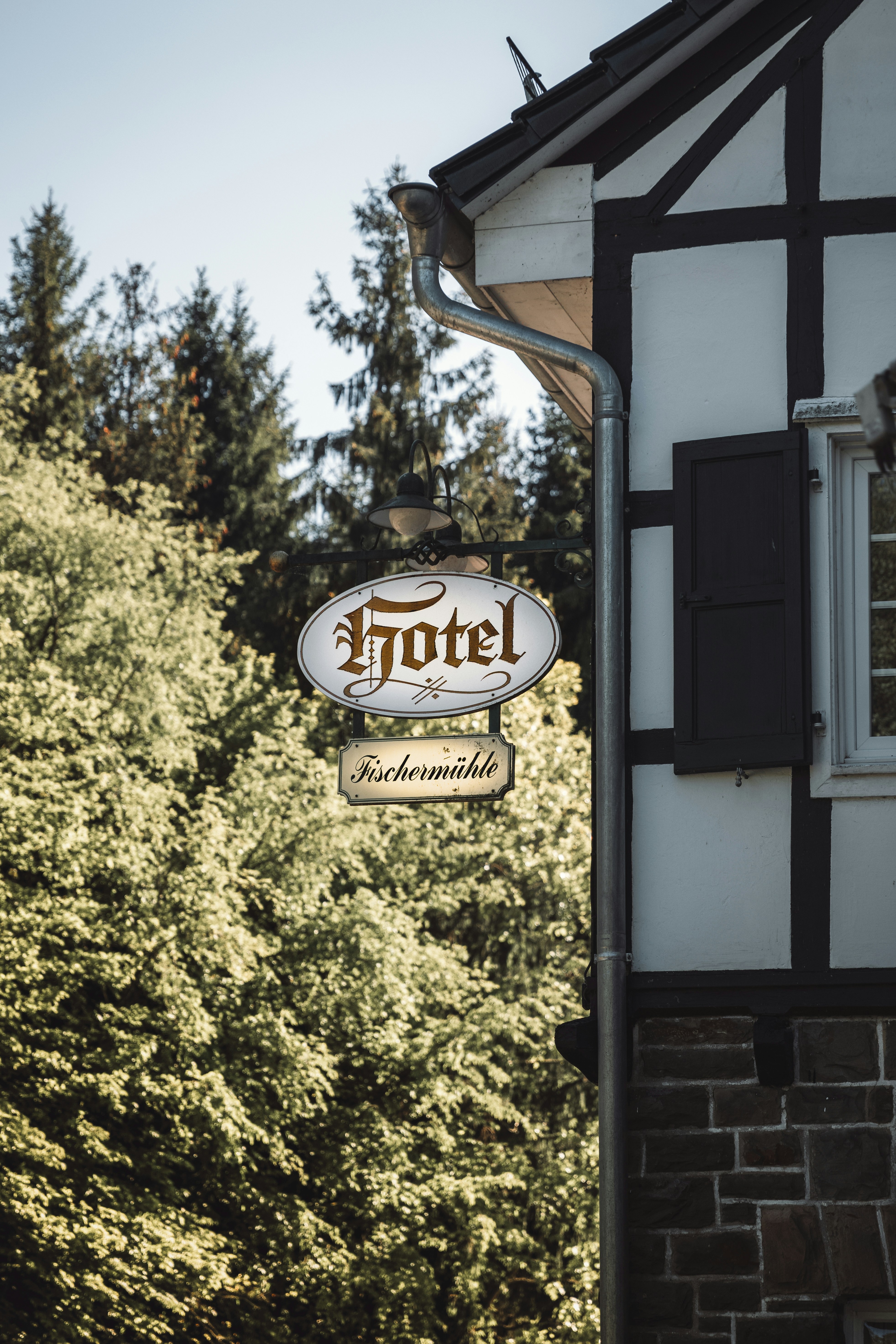 Fischerhütte Hotel Sign Adorning a Sunlit Timber-Framed Facade