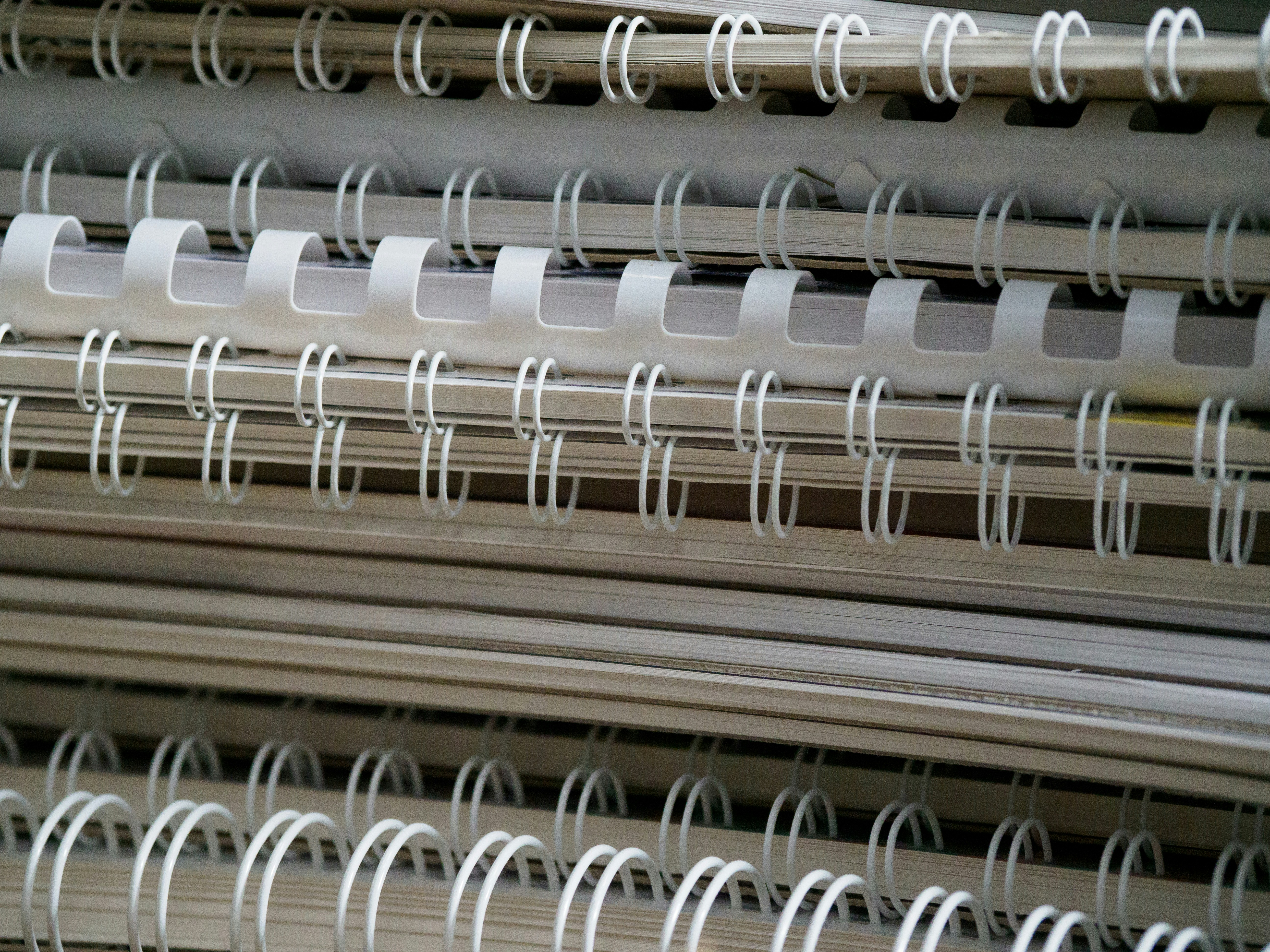 Coiled Ribbons: Close-up of Spiral Bindings in a Tangle of Paper