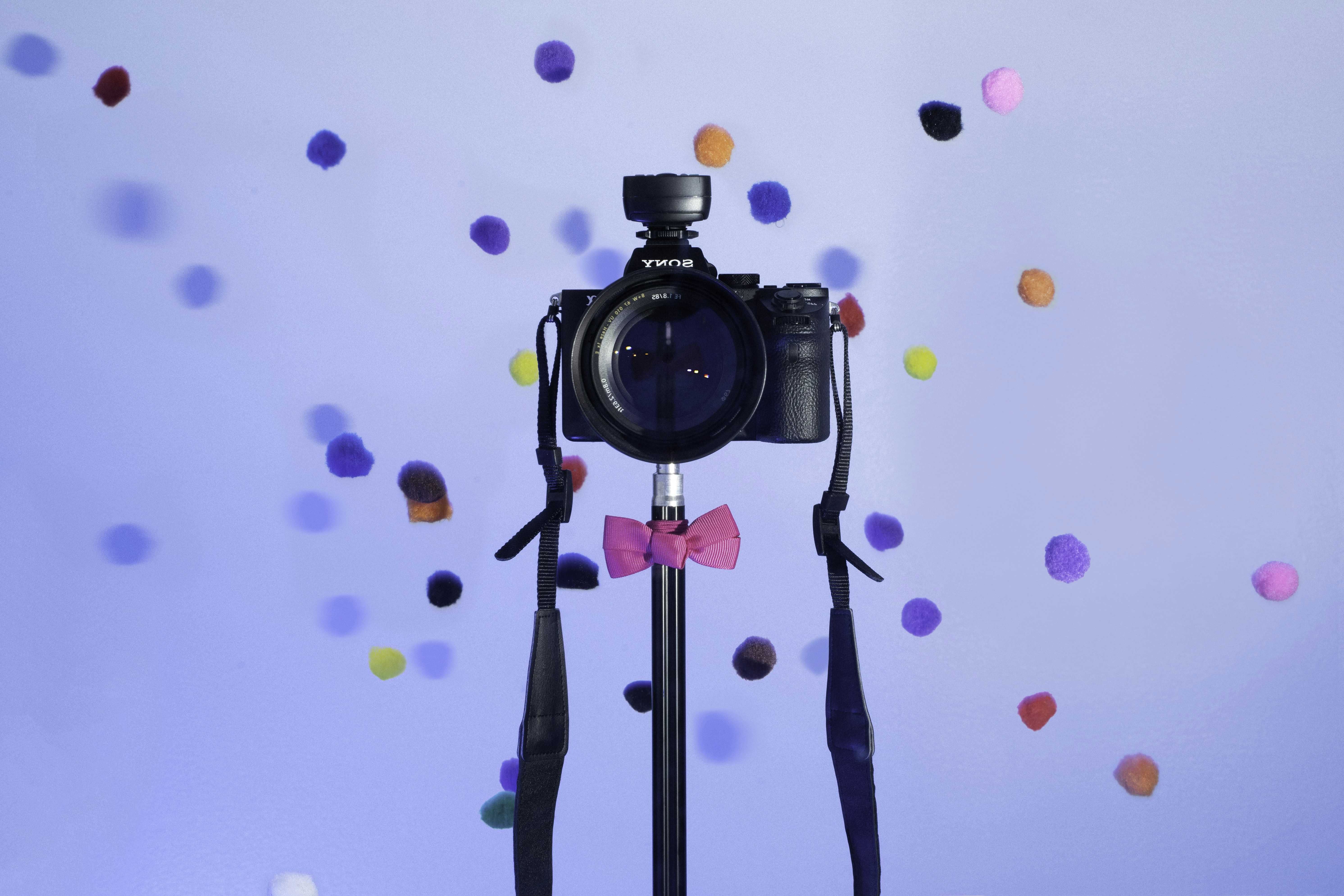 Center Stage with Confetti: A Bow-Tied Camera on a Tripod