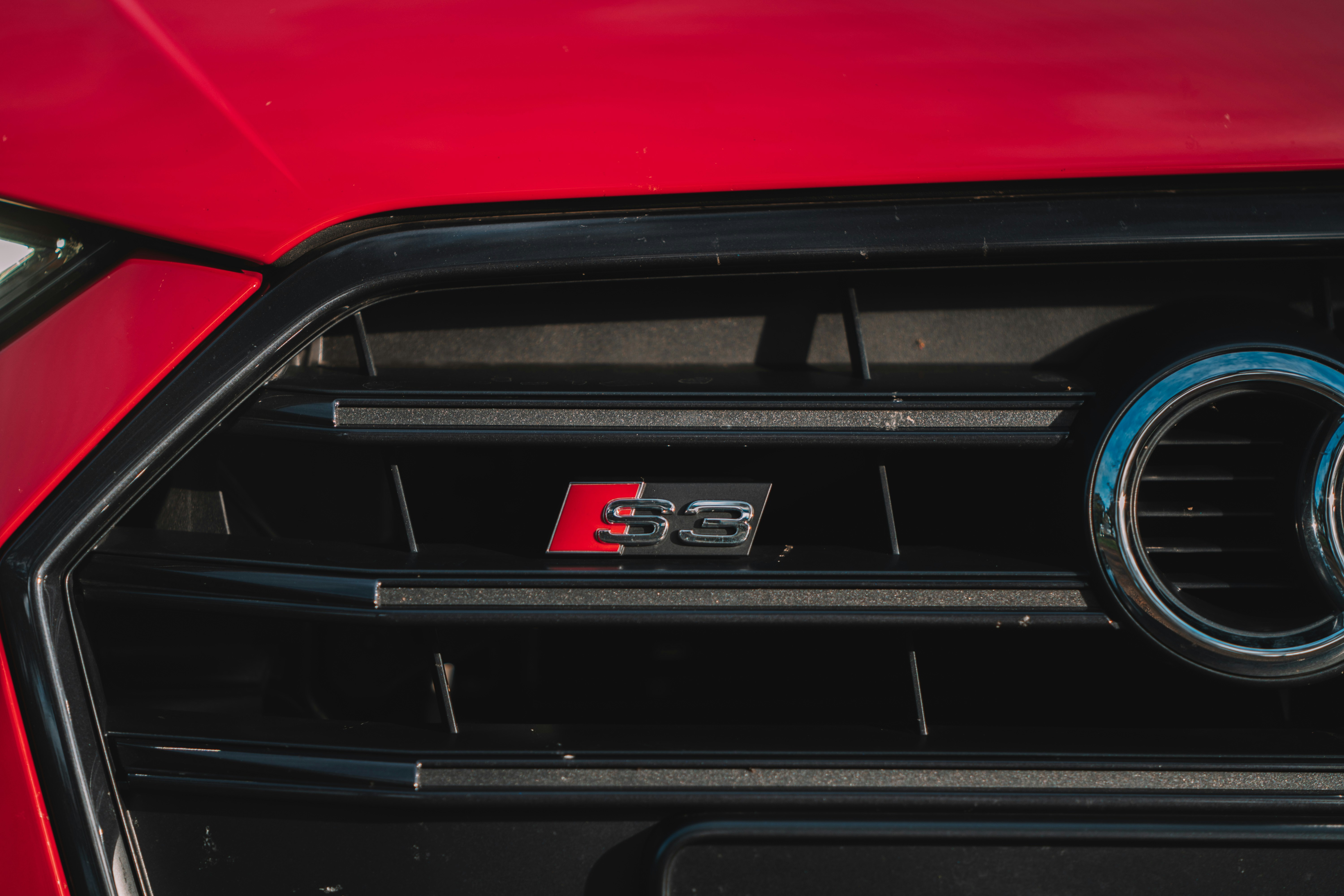 Inch of Power: The S65 Emblem Framed by Red Grille