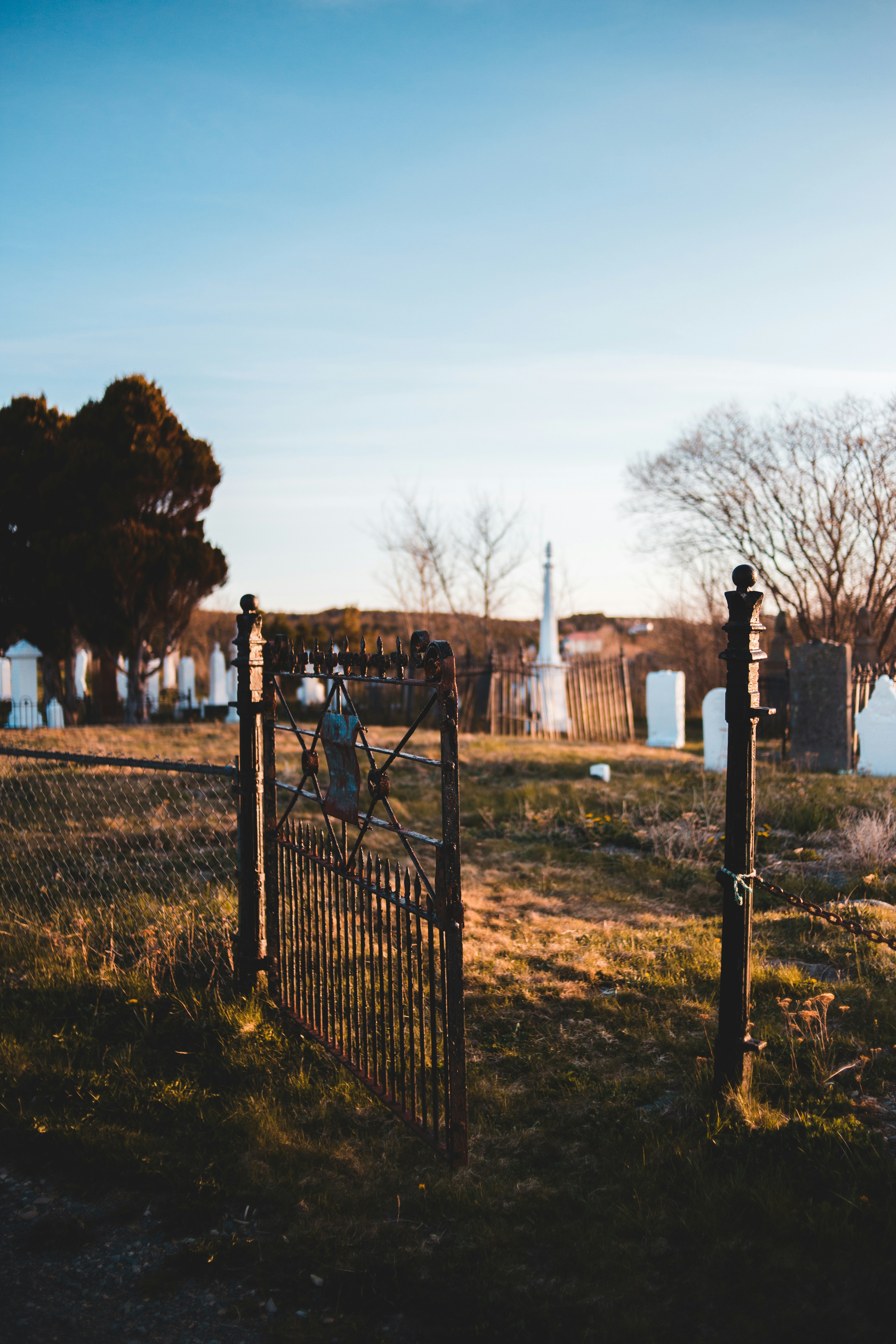 Whispering Gate at Golden Hour: An Open Entrance to a Quiet Cemetery