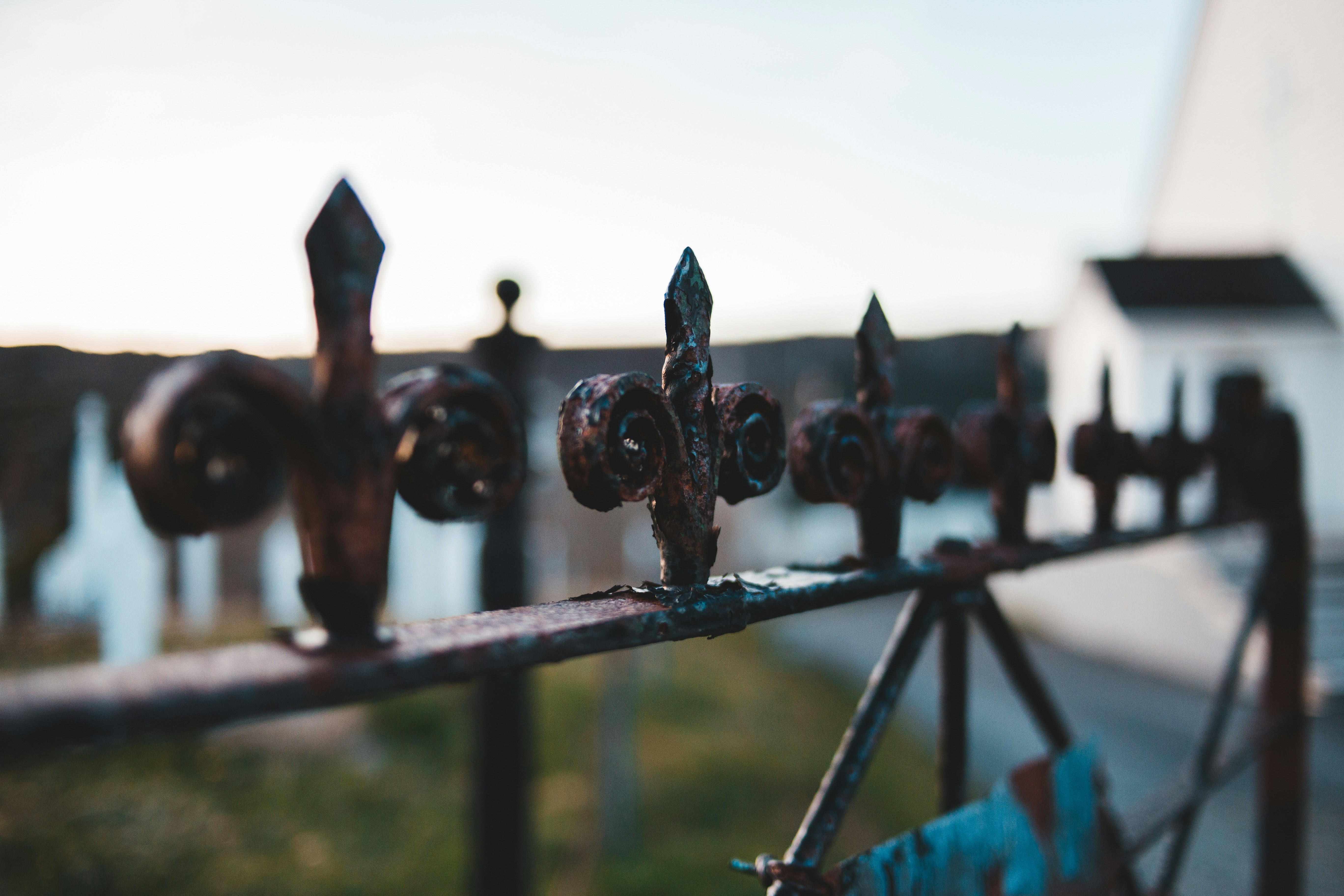 Rusty Iron Fences Reaching Toward a Quiet Horizon