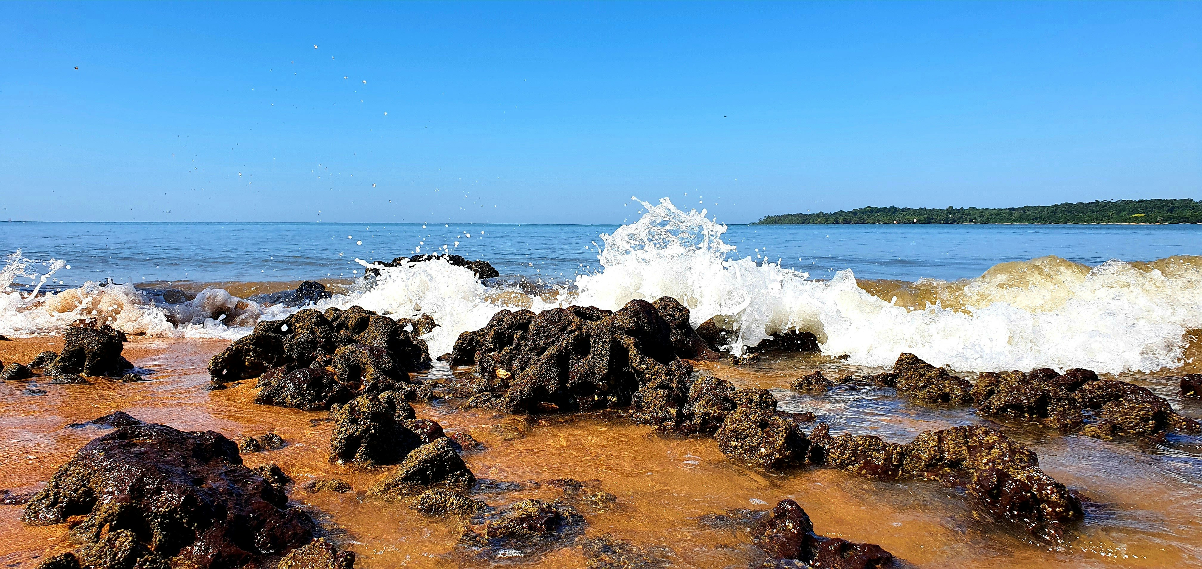 Sunlit Seafoam over Rugged Resplendent Rocks