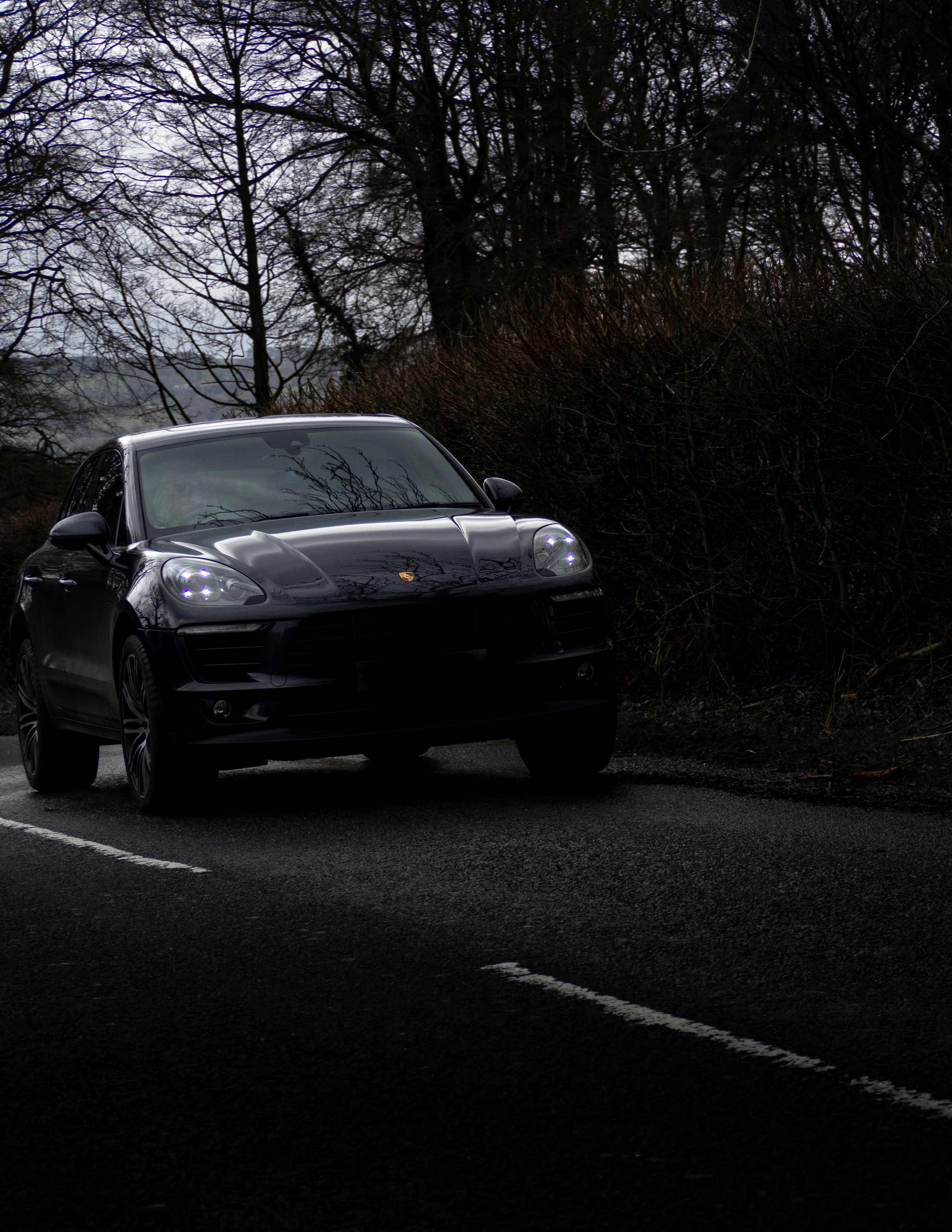 Dusk Run: Porsche SUV Carves a Quiet, Shadowed Road