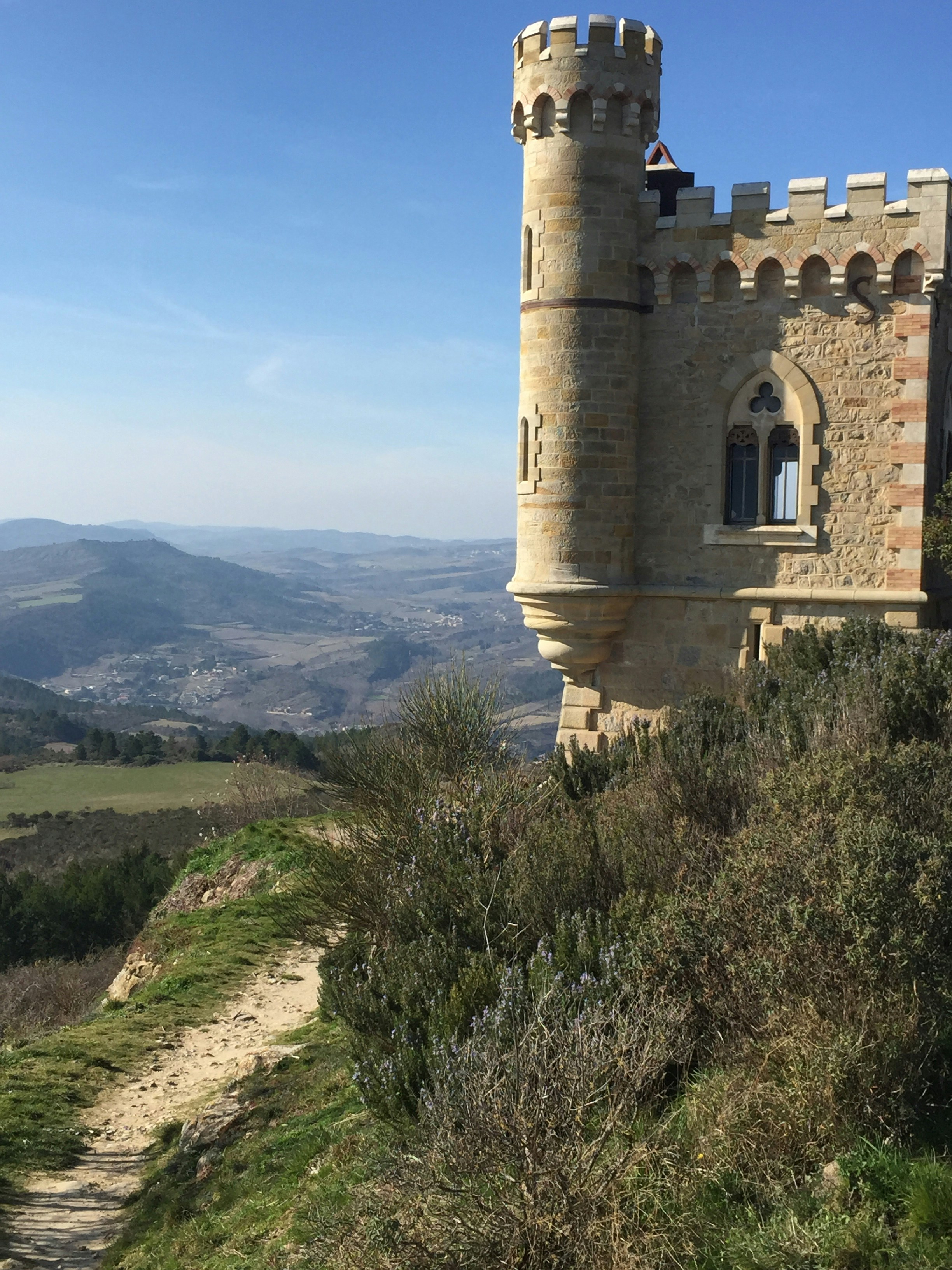 A stone castle on a hill overlooking a valley photo – Free 7 le village ...