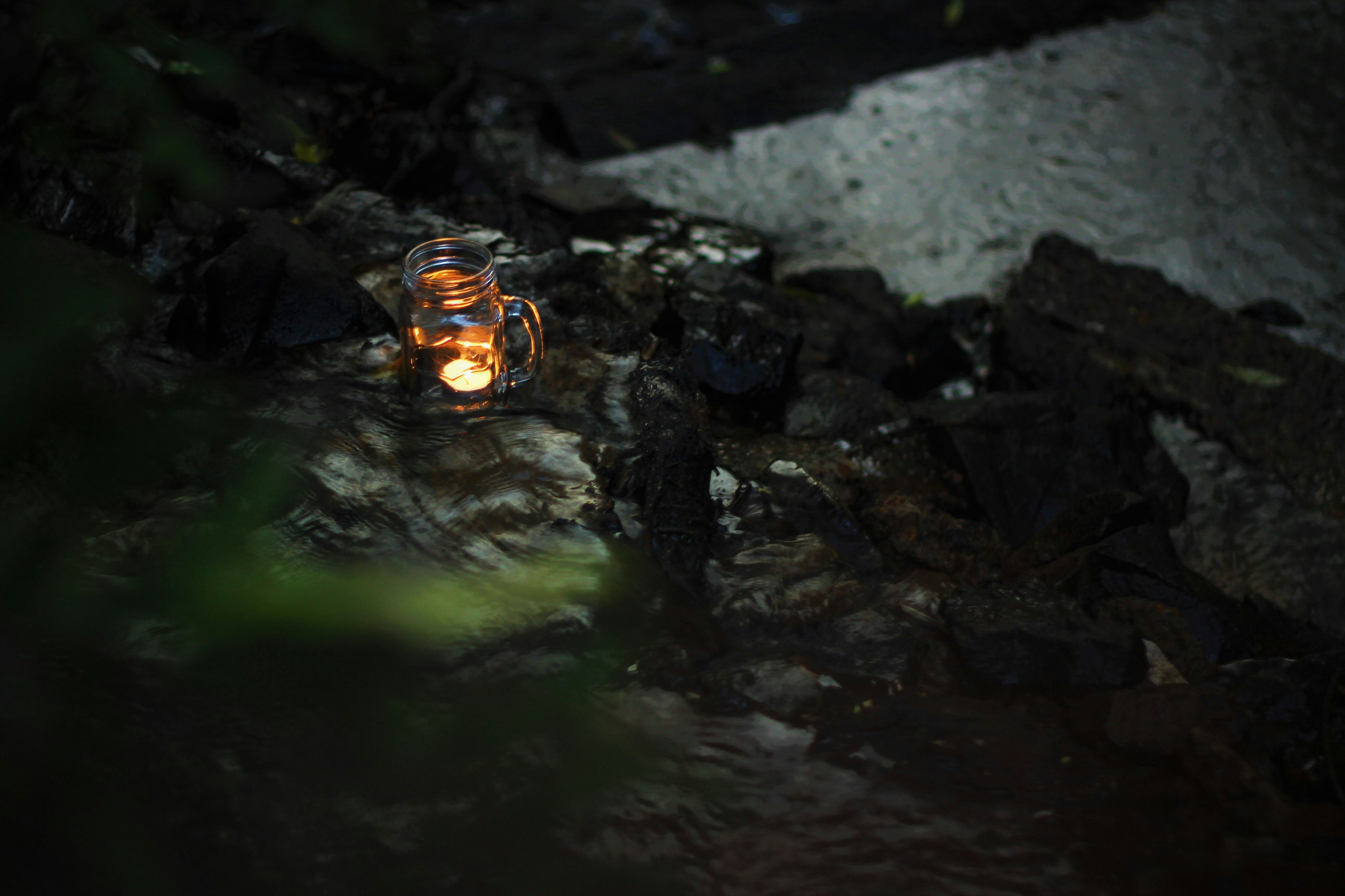Amber Lantern on Wet Stones: Quiet Light by the River