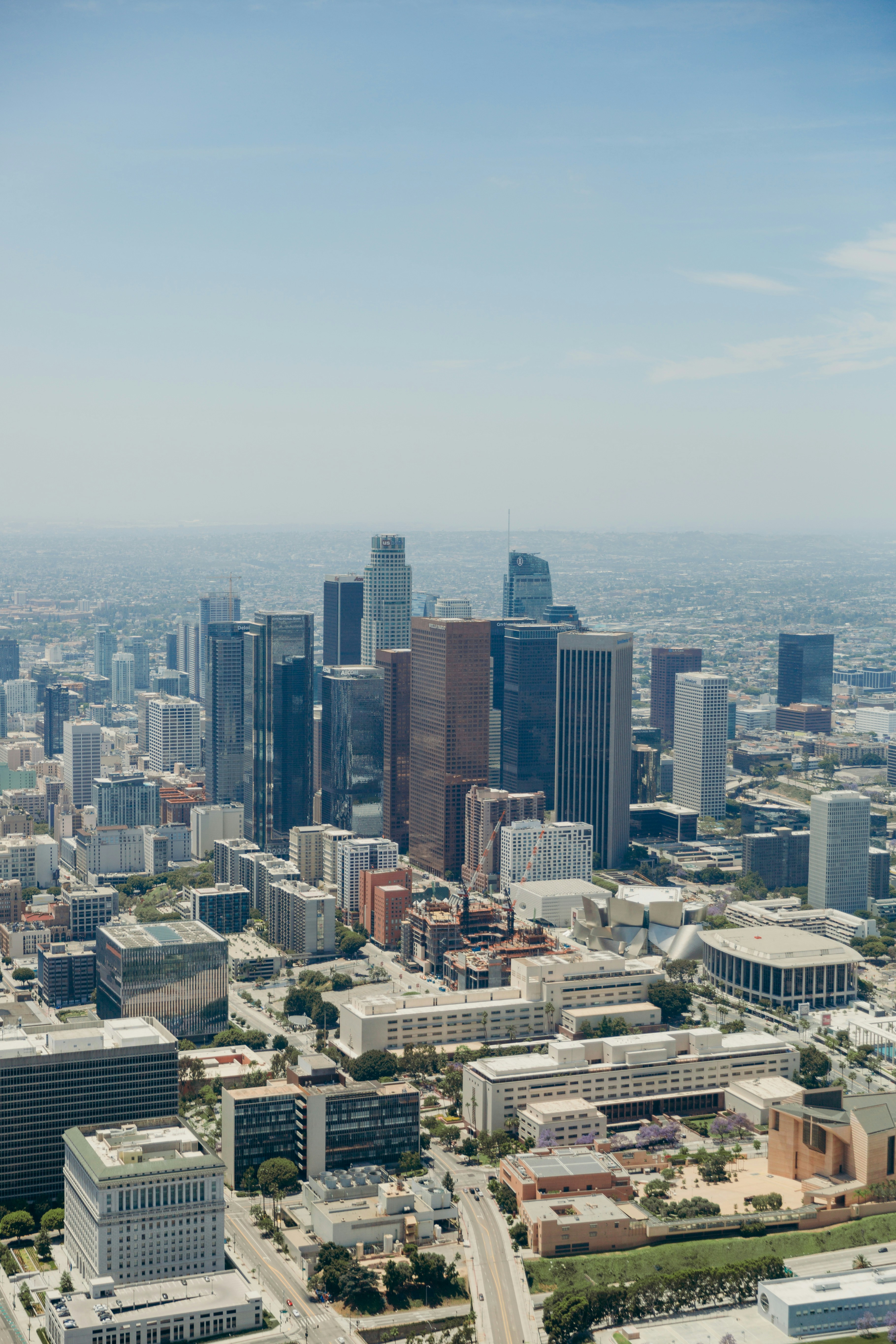 Aerial view of downtown Los Angeles showcasing a blend of modern skyscrapers and urban architecture. The scene captures the vibrant essence of city life.