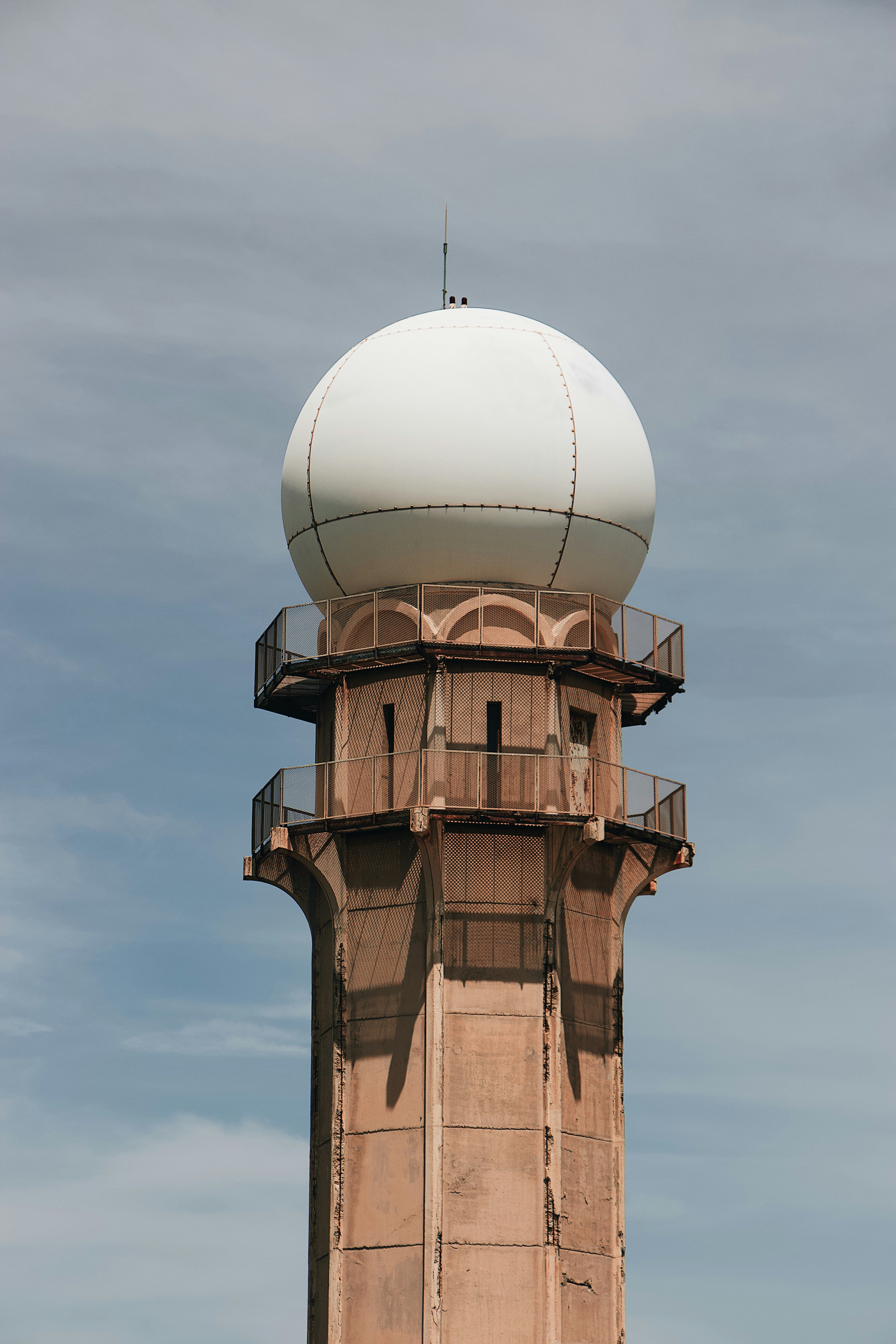 Brown and white concrete tower under blue sky during daytime photo ...
