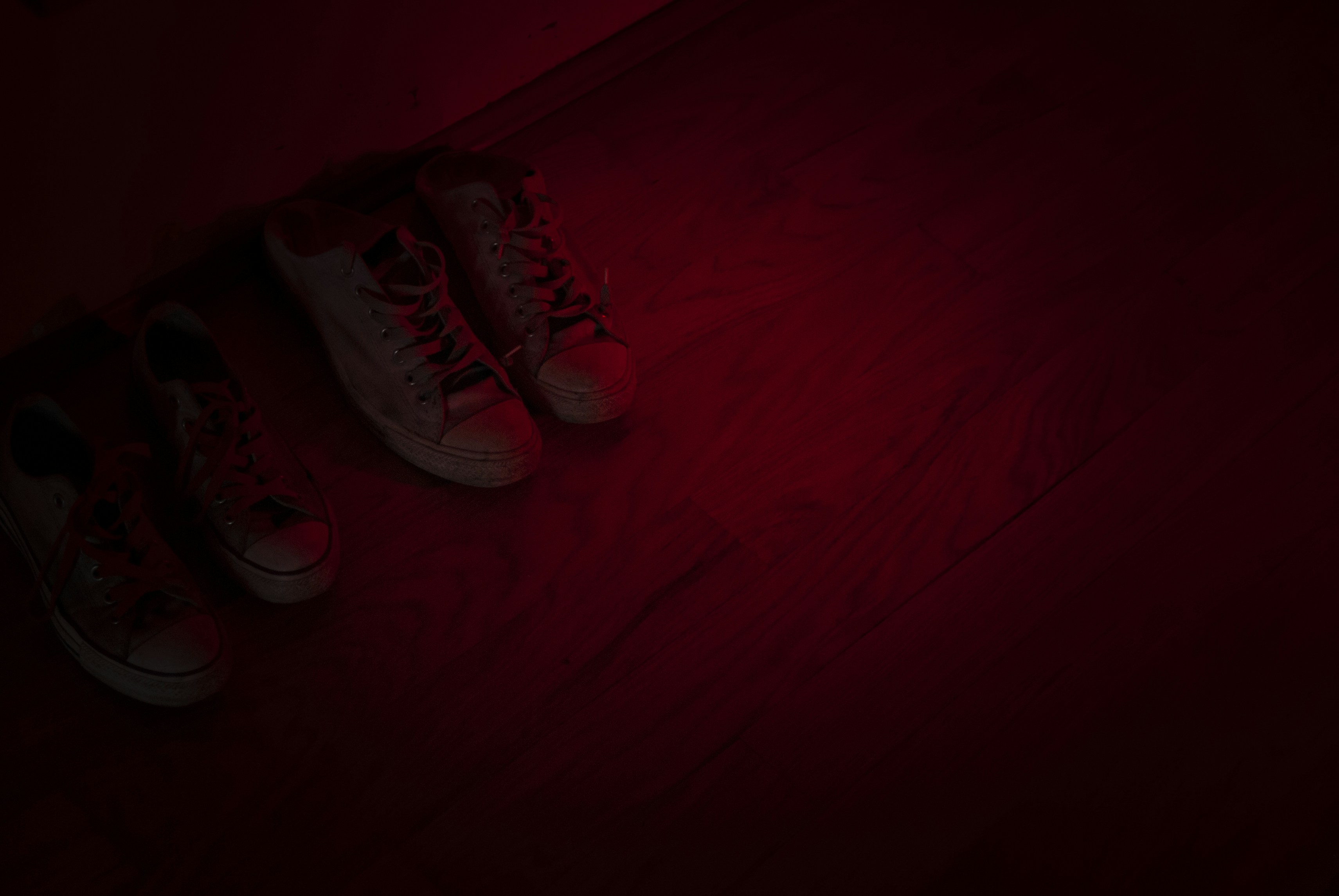 Old sneakers in a red light.