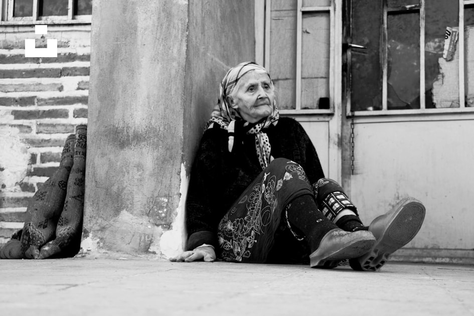 Woman In Black And White Floral Dress Sitting On Floor Photo Free