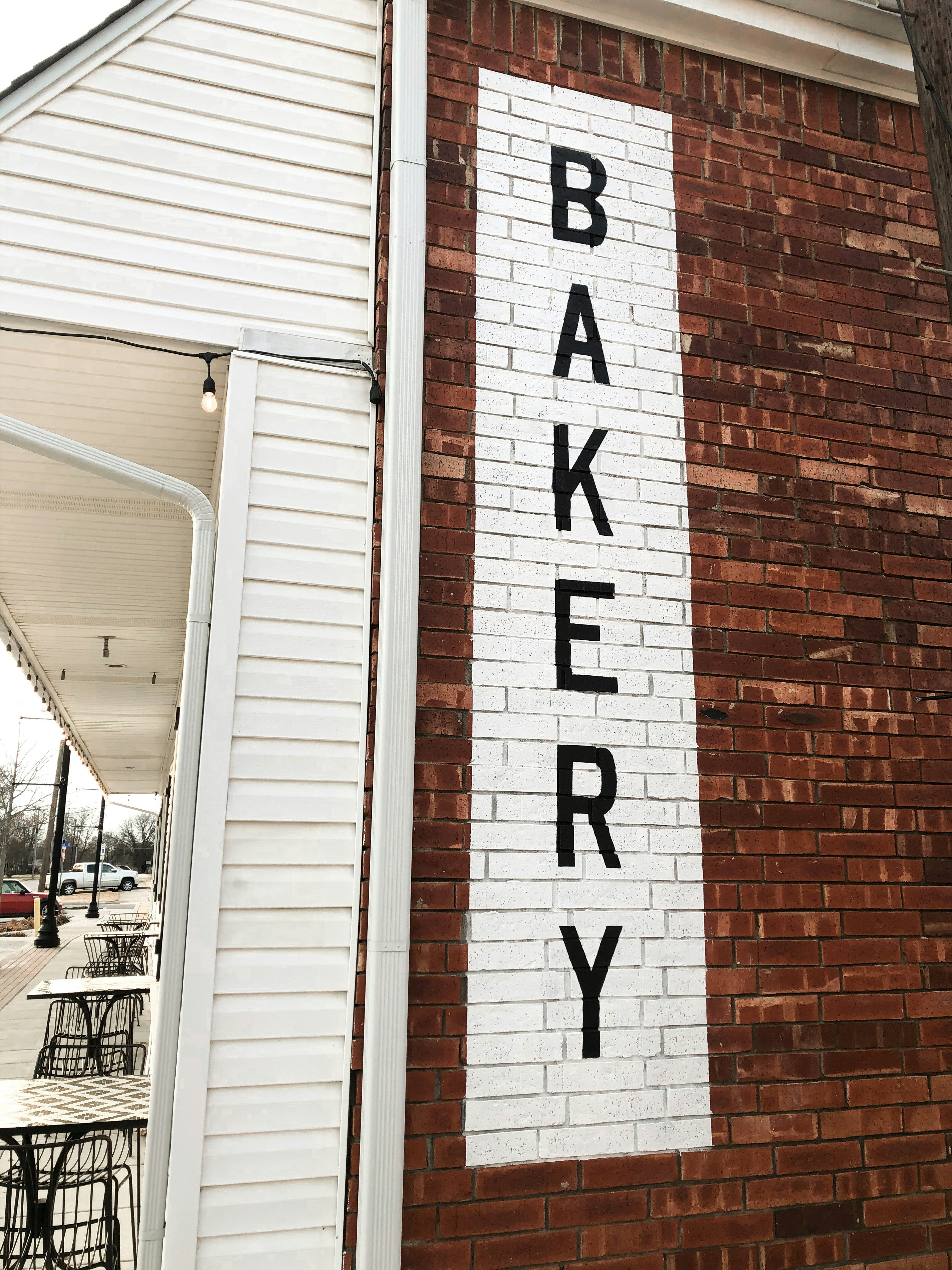brown brick building with white and brown wooden door
