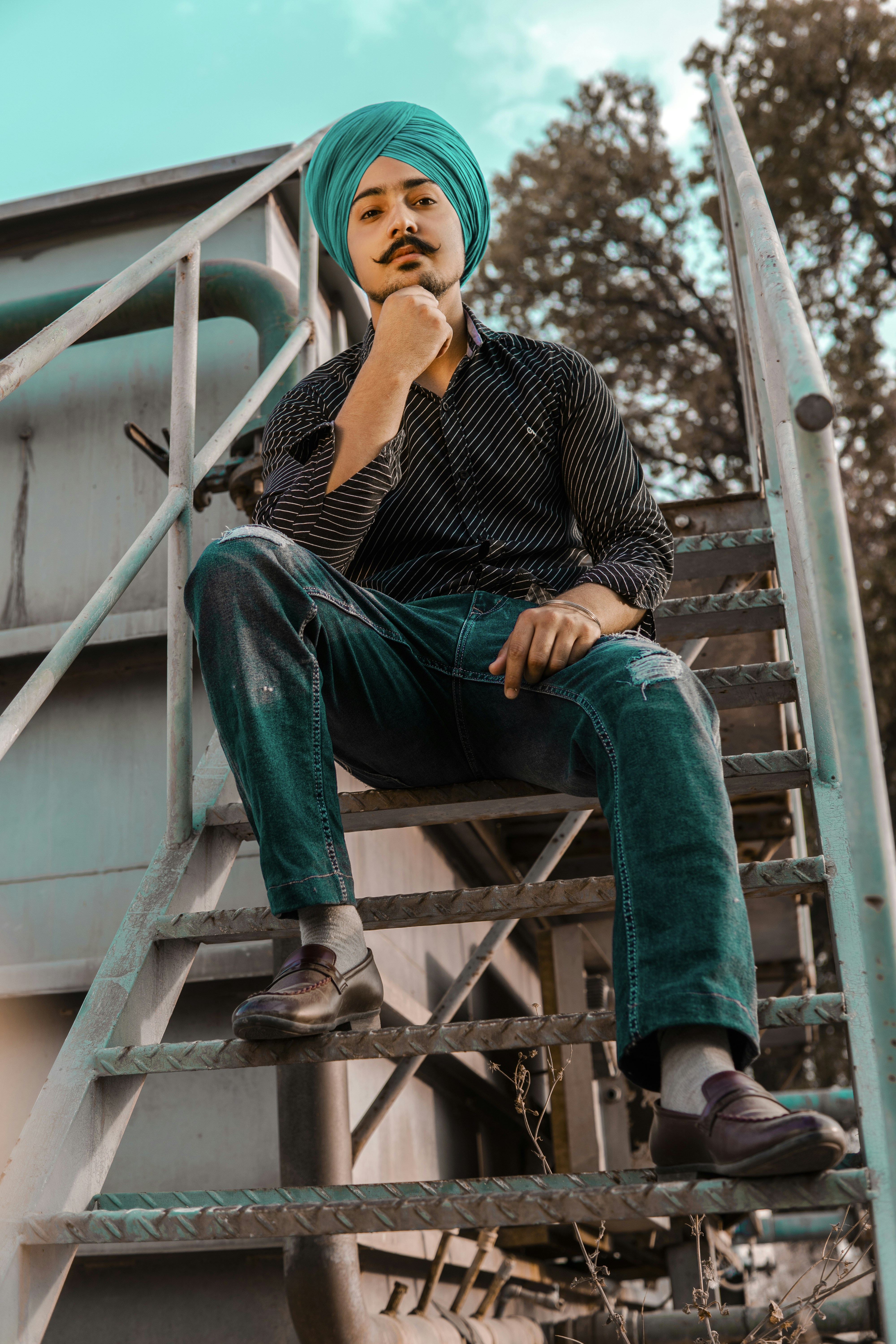Turquoise Turban, Quiet Confidence: A Street-Style Portrait on Metal Stairs