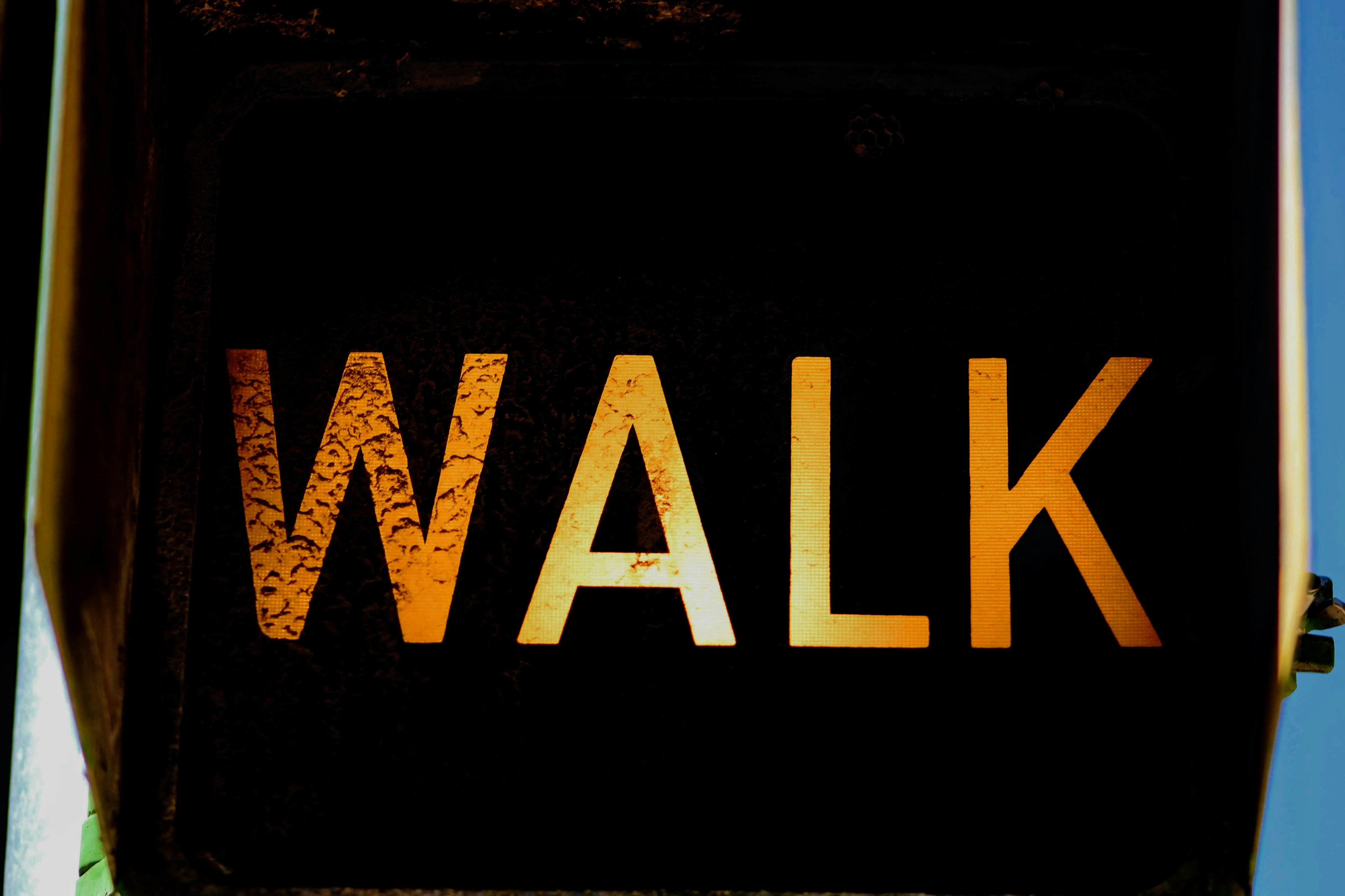 Walk Signal Glisten: A Close-Up of a Timeless Street Marker
