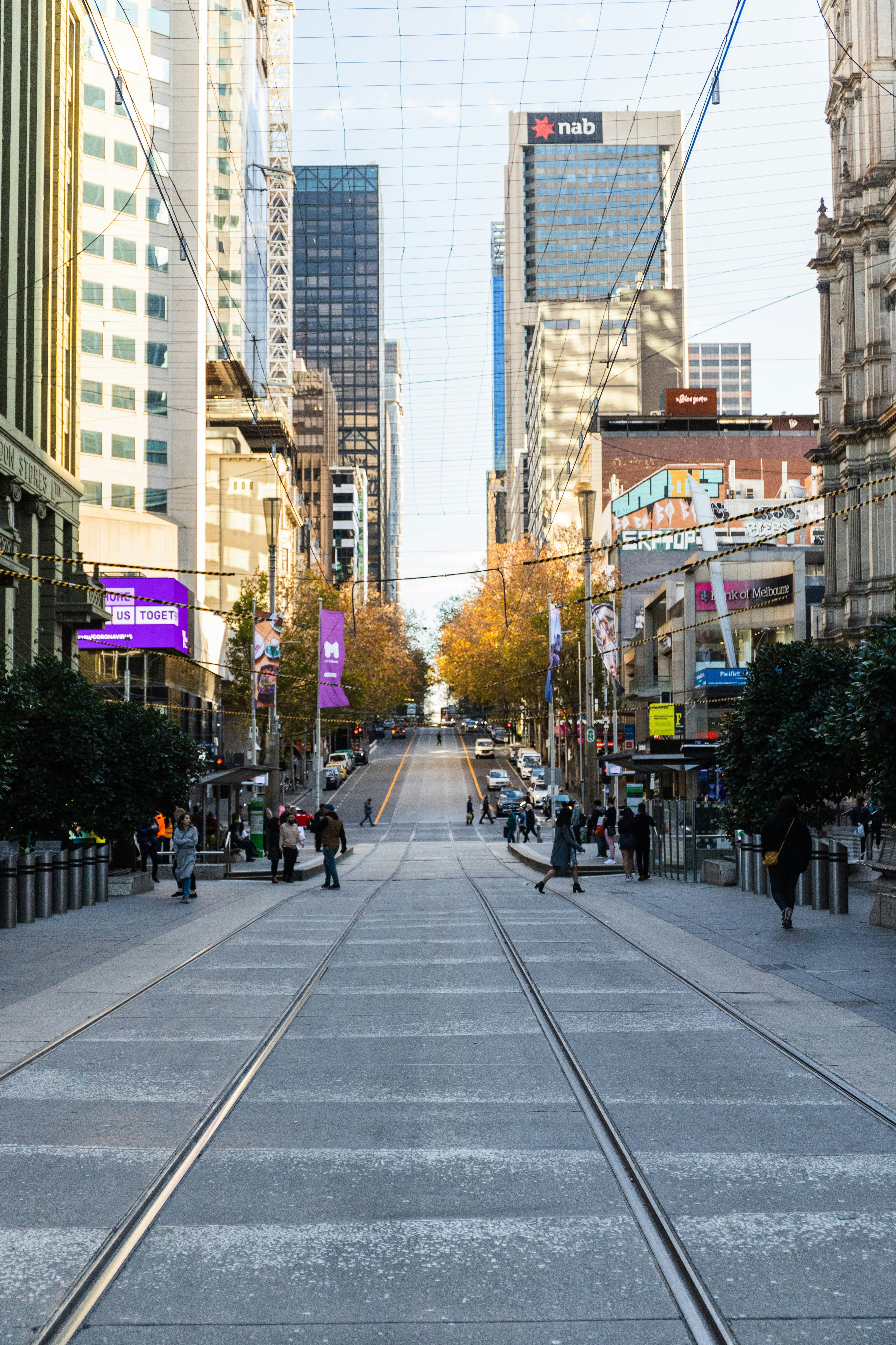 People walking on sidewalk near high rise buildings during daytime ...