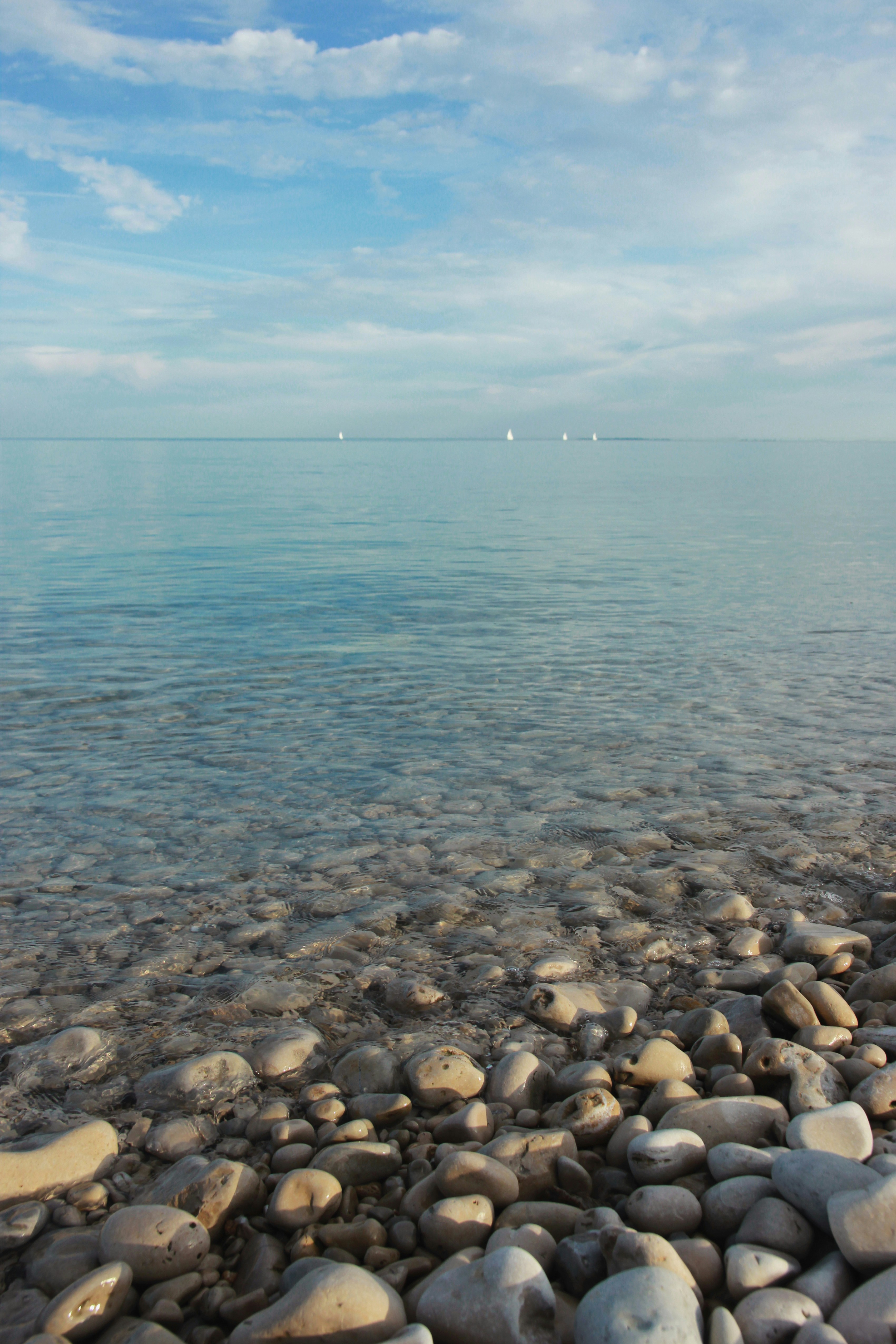 Pebble Beach at Dusk: Calm Sea Meets Shoreline