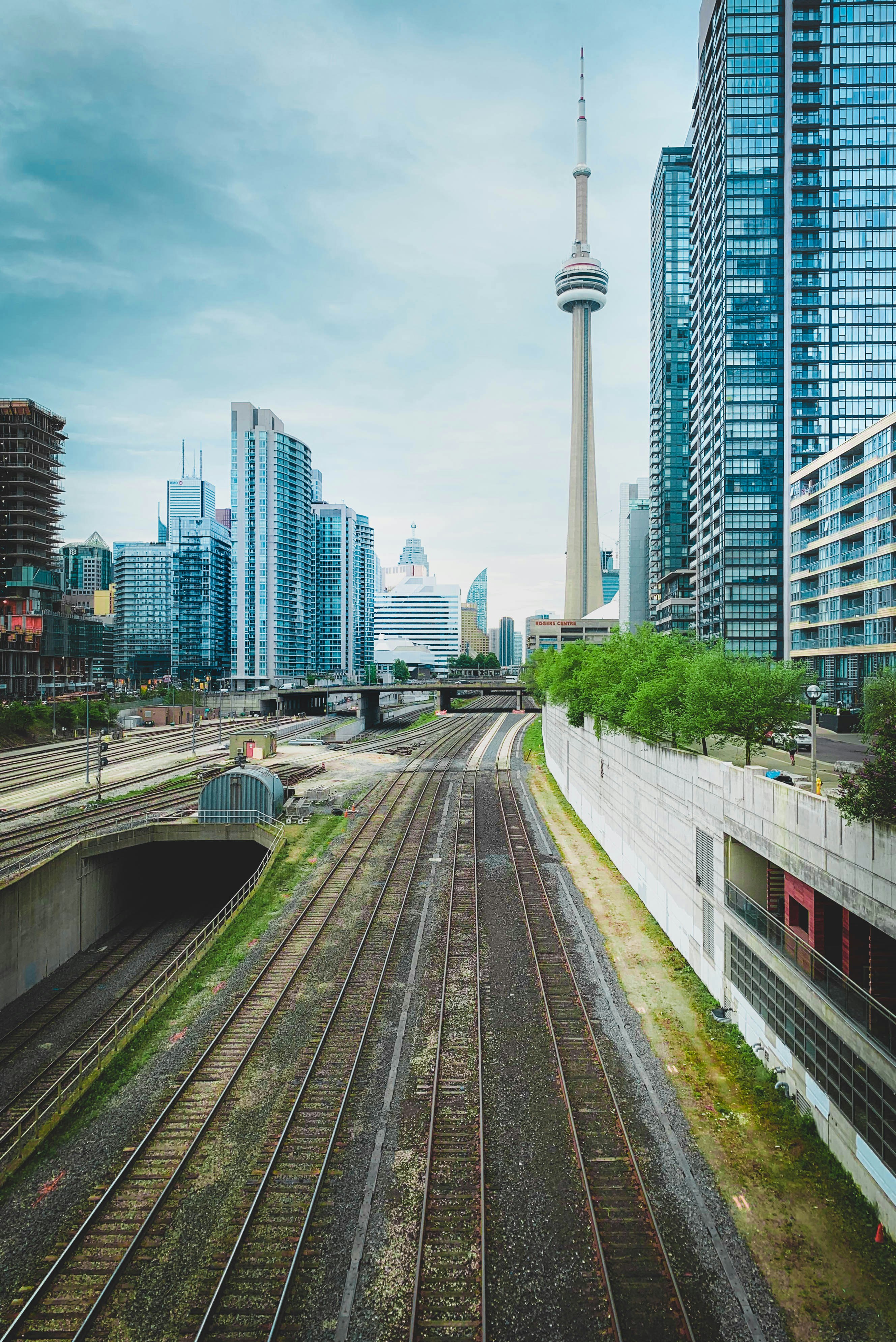 Converging Rails: Toronto's CN Tower Rising Through a Glass City