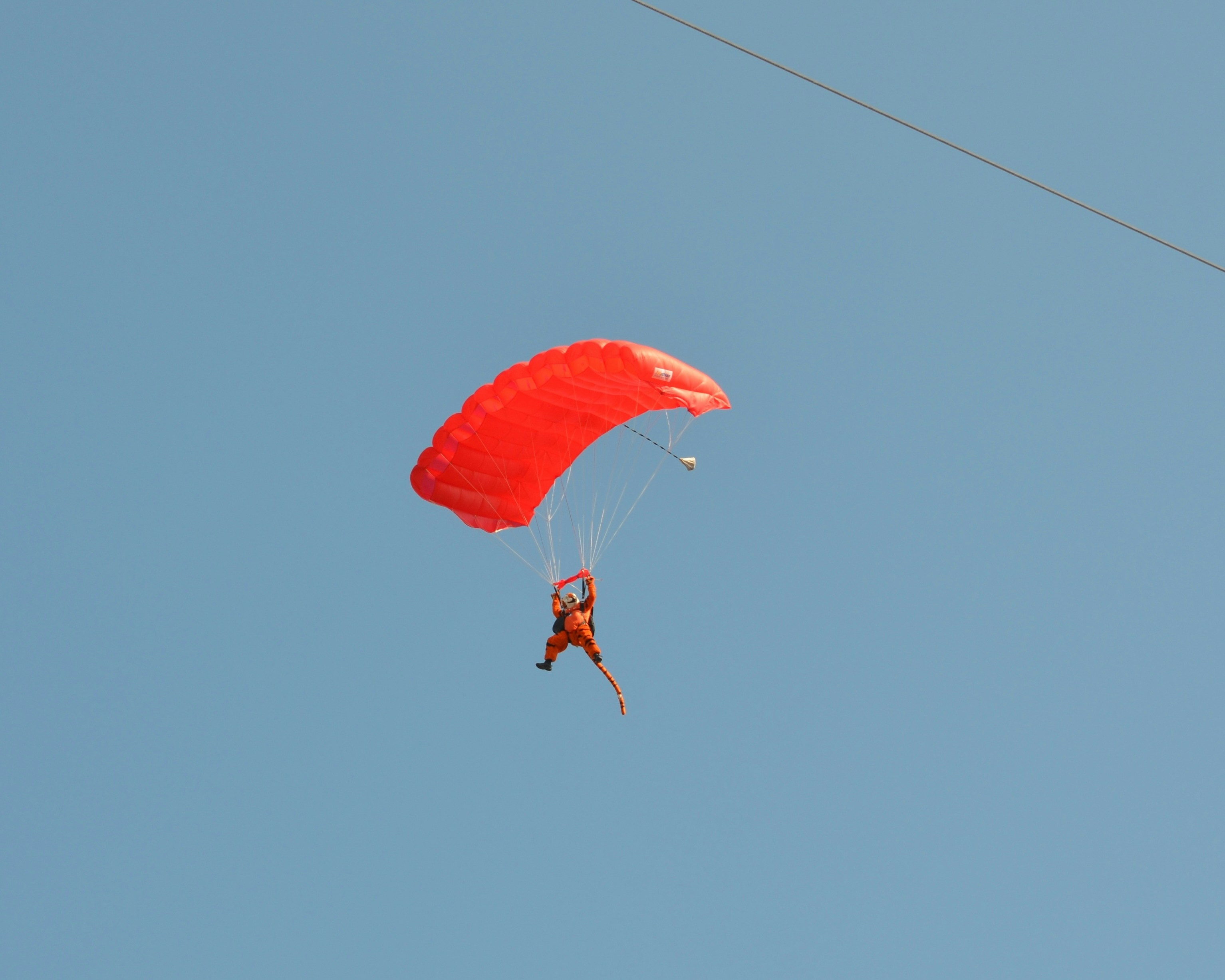 Person in red parachute under blue sky during daytime photo – Free Red ...
