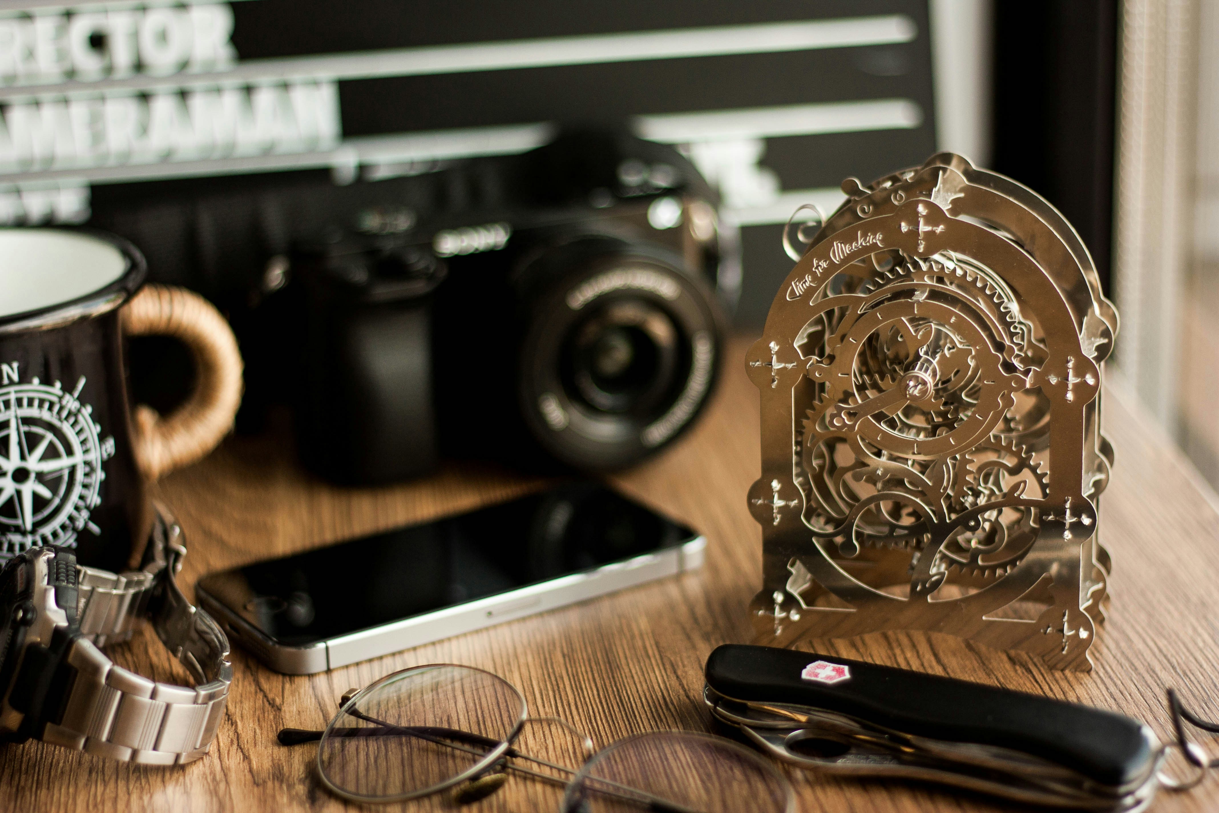 Curiosities on a Wooden Surface: A Vintage Still-Life with Gear and Glass