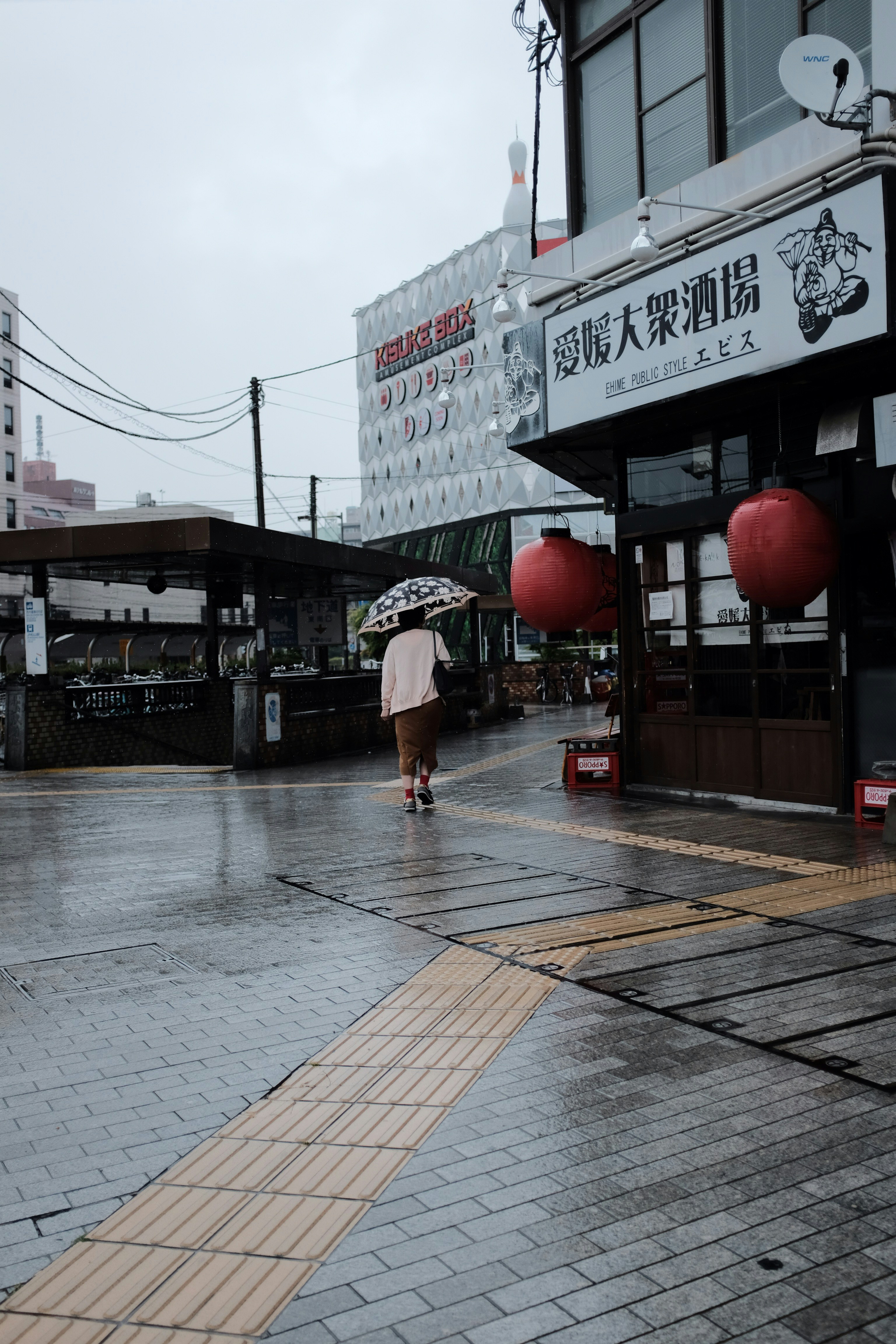 woman in white dress walking on sidewalk during daytime