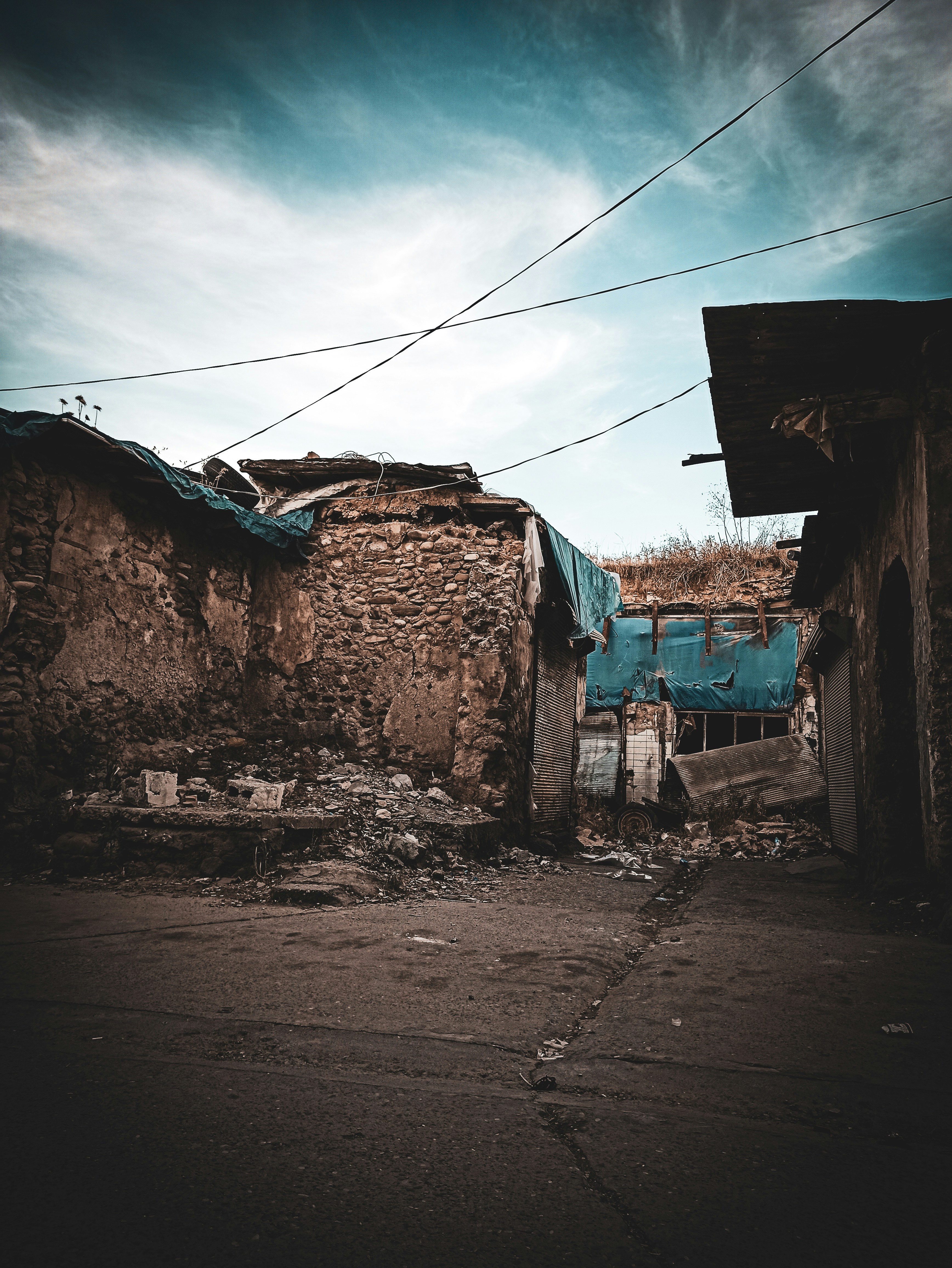 Old street in Kurdistan | brown concrete houses under white clouds during daytime