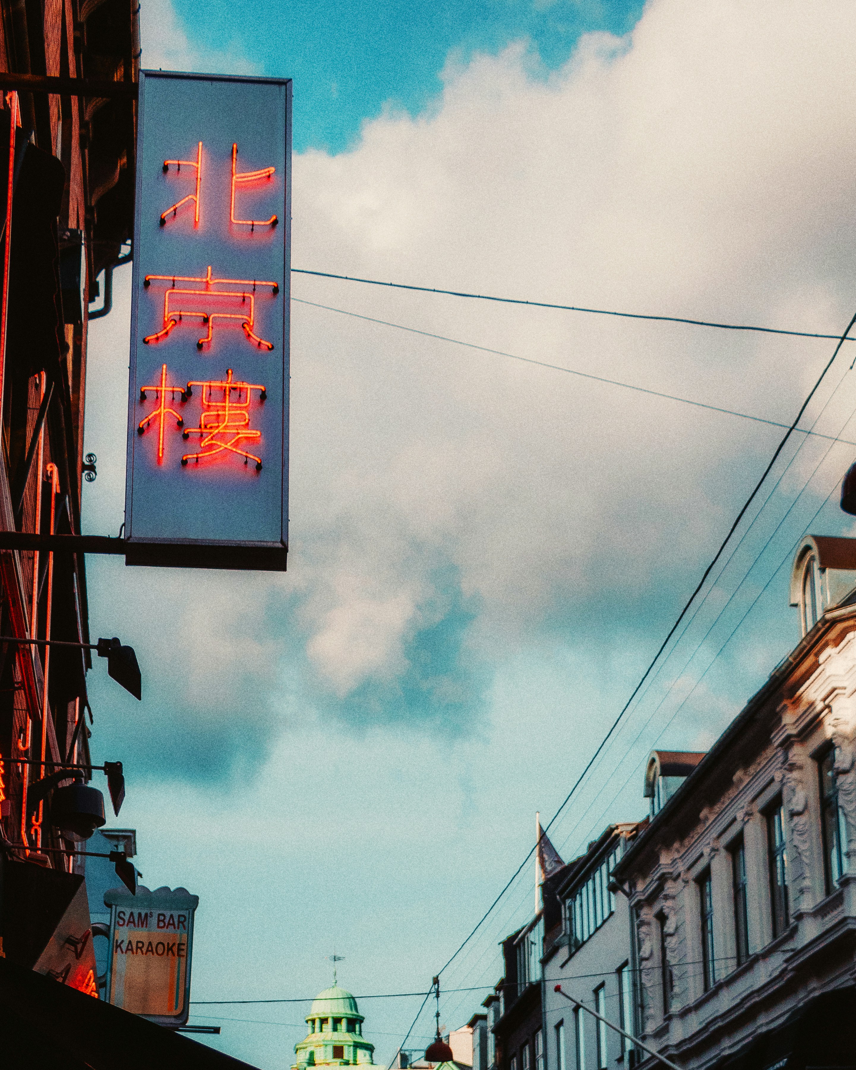 Neon Sign Over Chinatown Street at Dusk