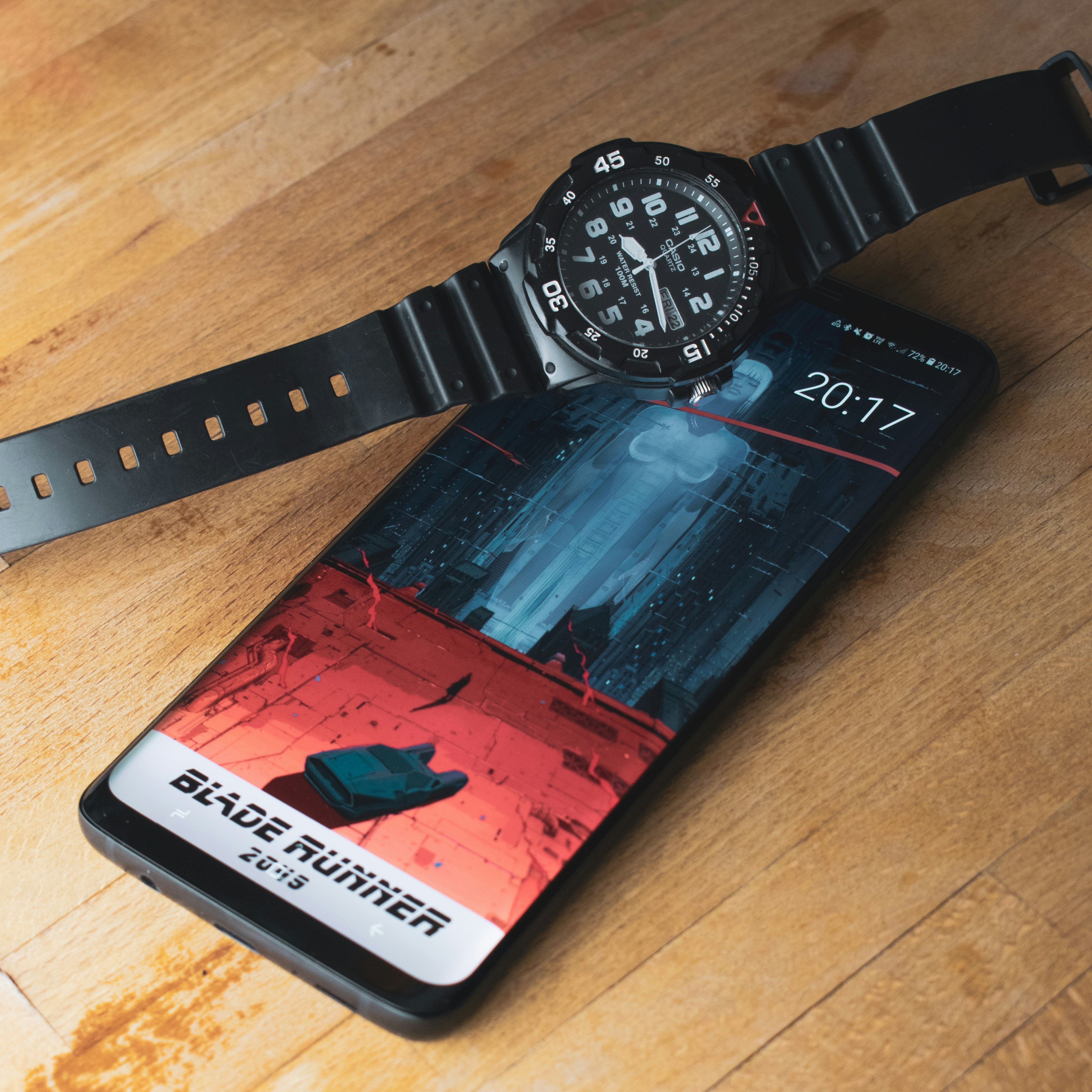 Watch Over Neon City: A Blade Runner-Inspired Phone Resting on Wood