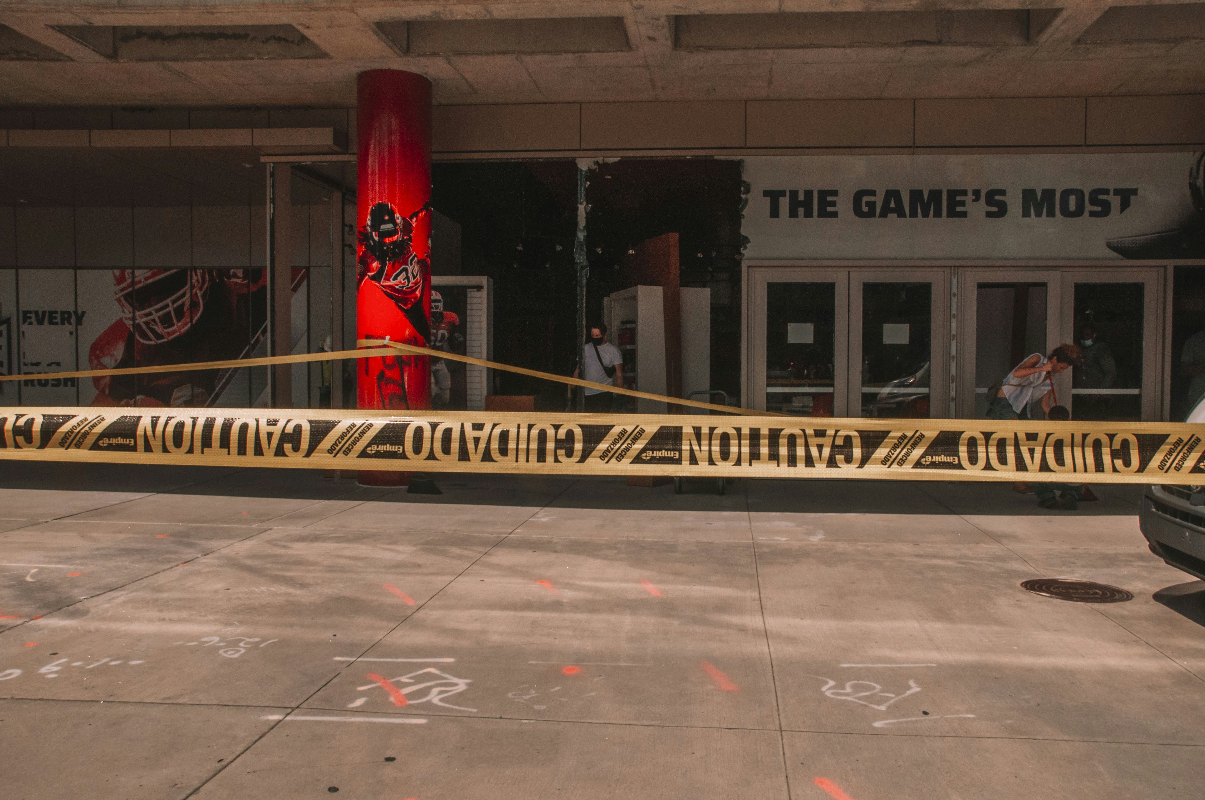 A yellow caution tape blocking off a parking lot photo – Free Current ...