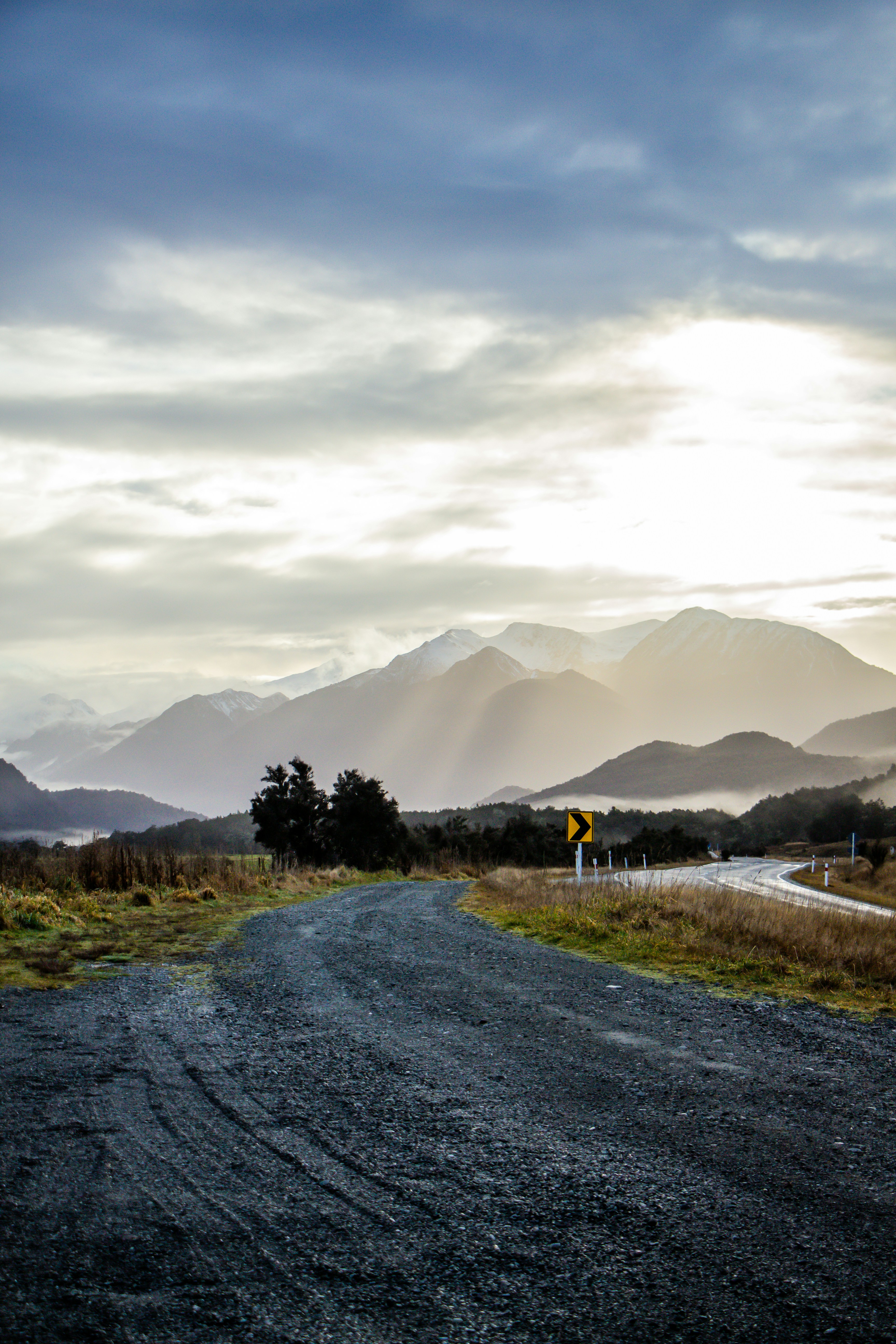 People walking on pathway near green trees and mountains during daytime ...