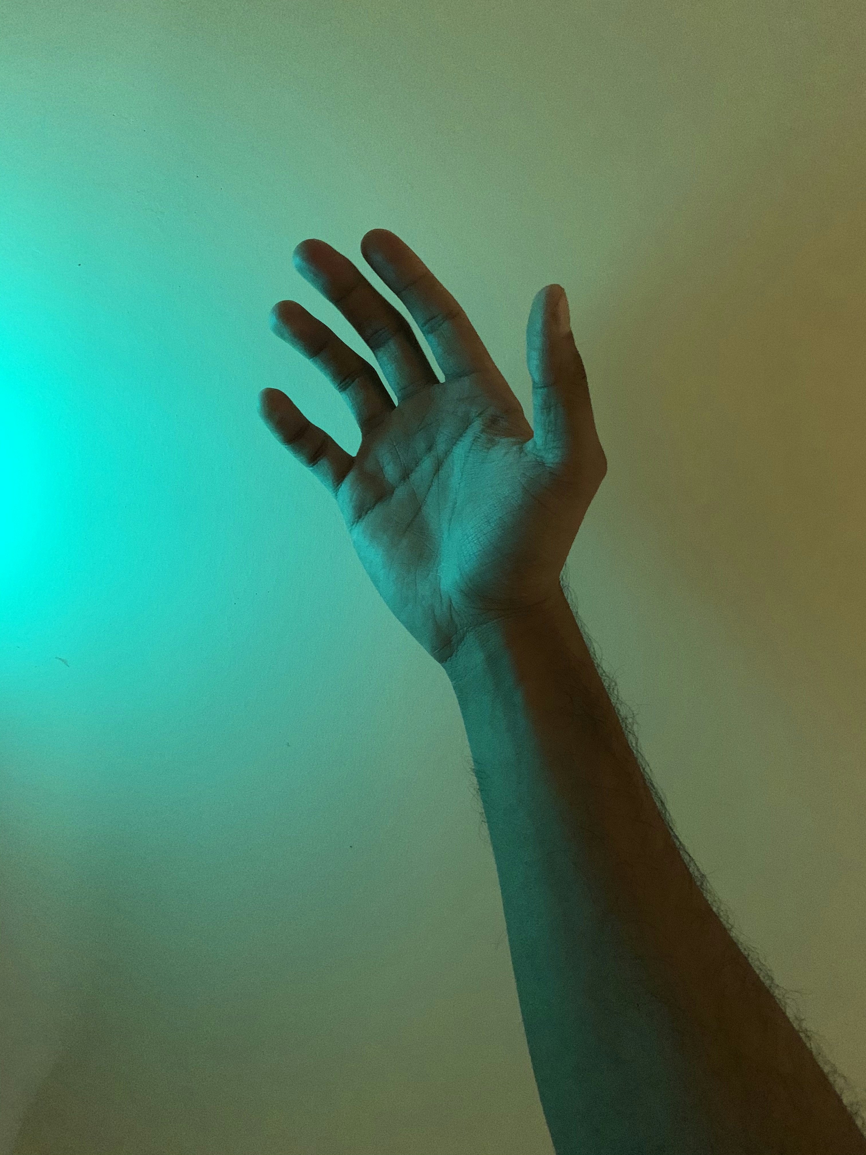 Neon Reach: A Hand Emerges Through Gradient Light