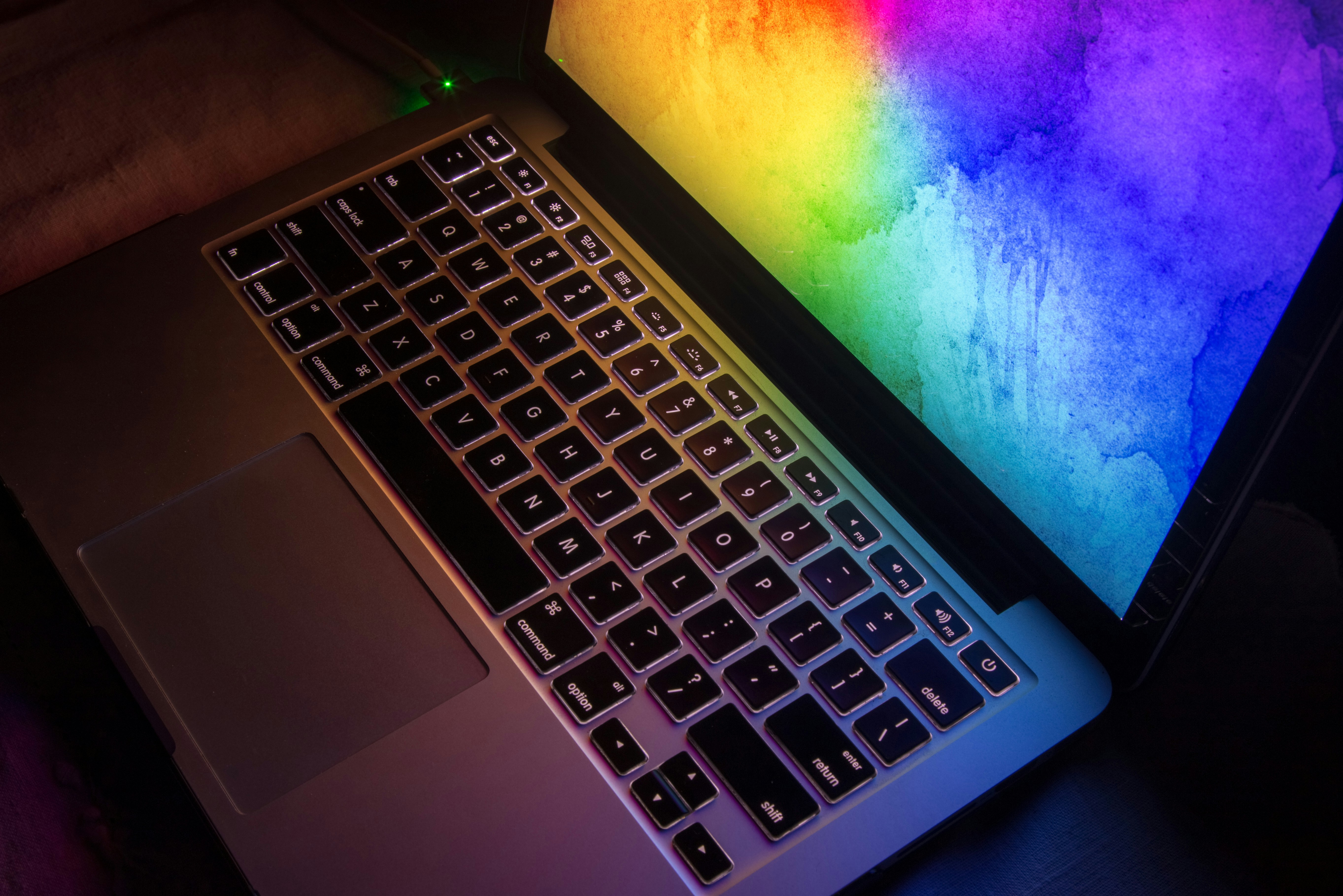 Chromatic Keyboard Lattice: Rainbow Screen Illumination on a Silver Laptop
