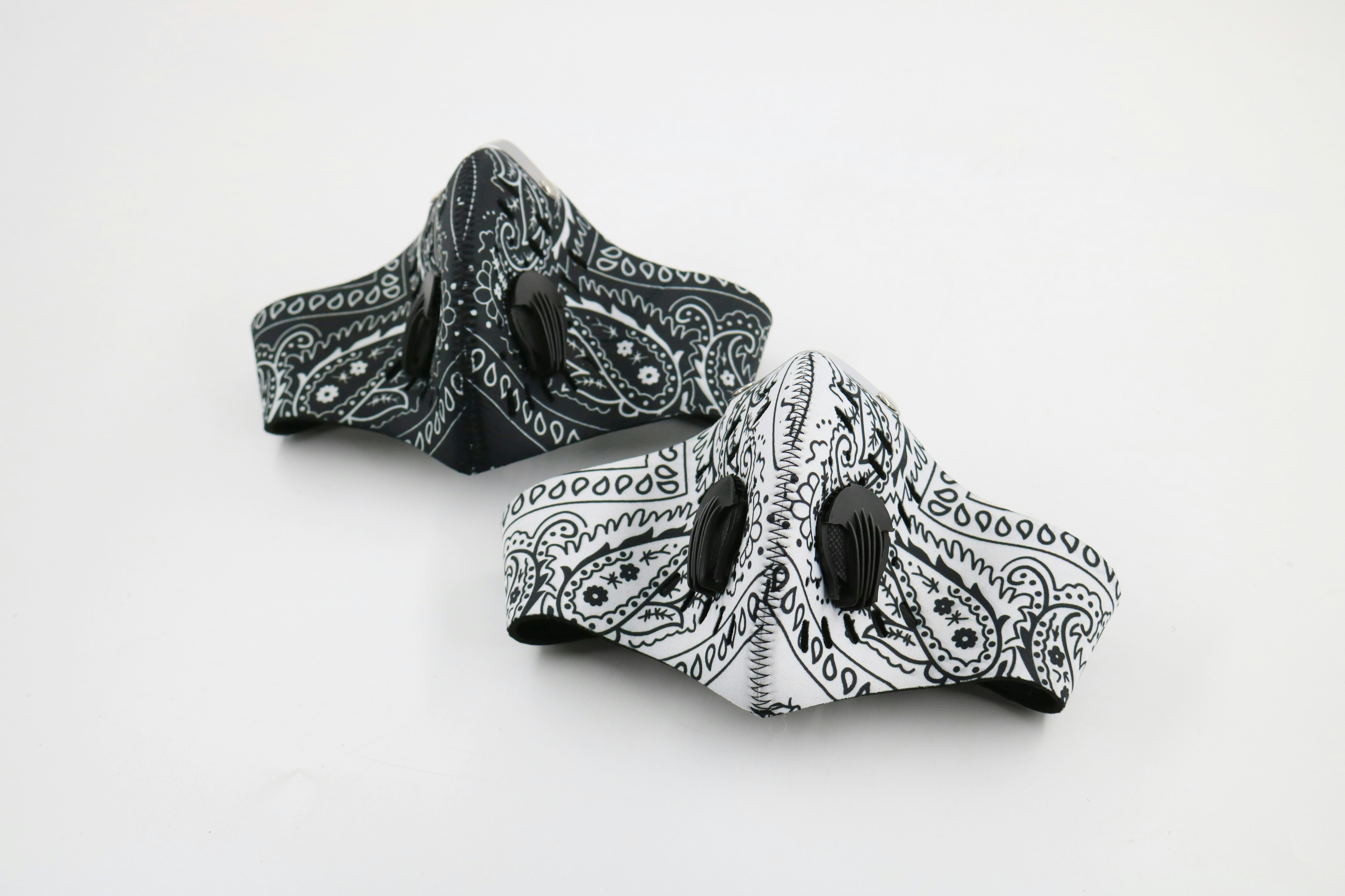 Two bandana-patterned masks in contrasting colors, showcasing intricate designs and adjustable features.