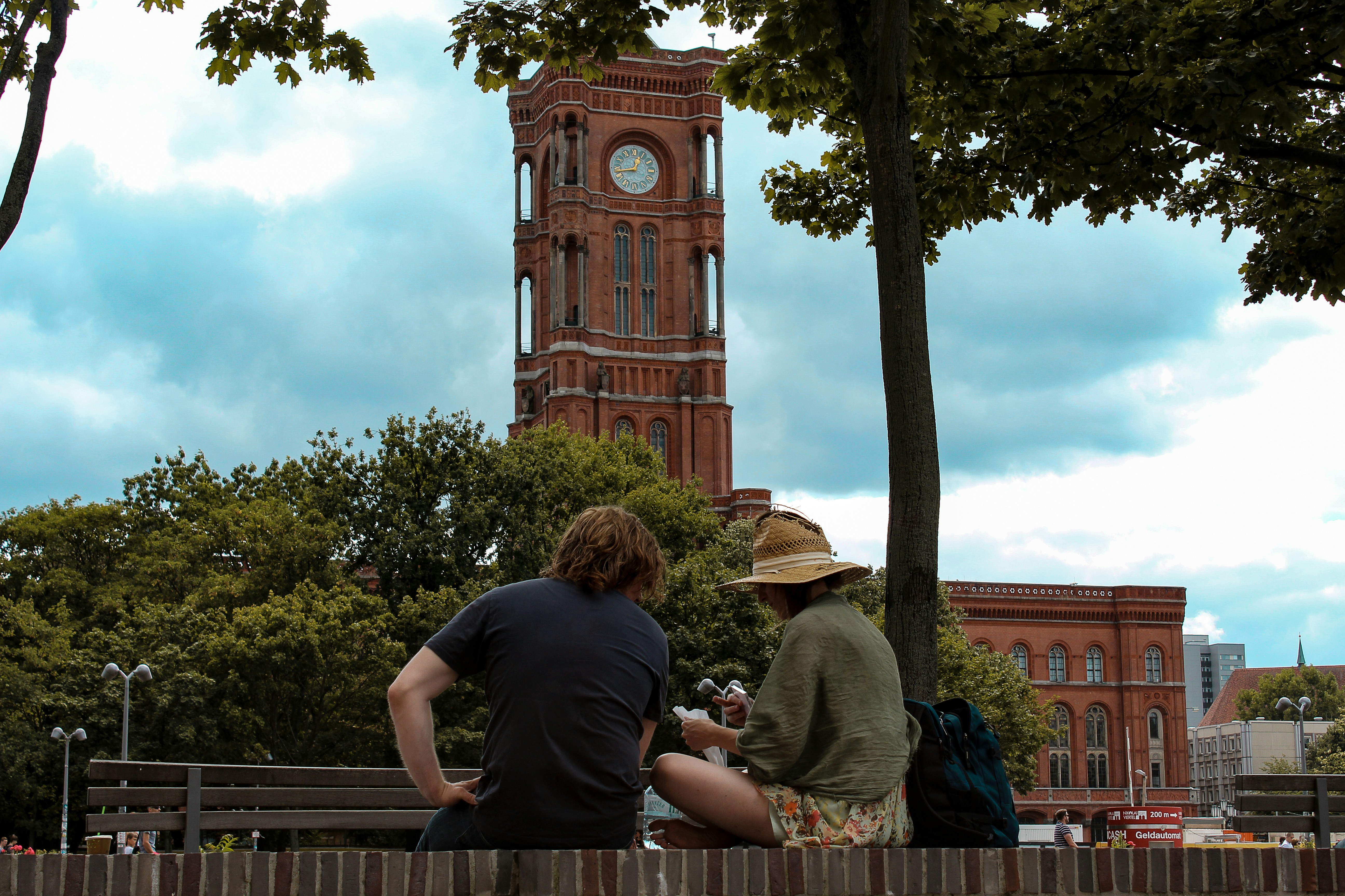 Benchside Moment under a Brick Clock Tower