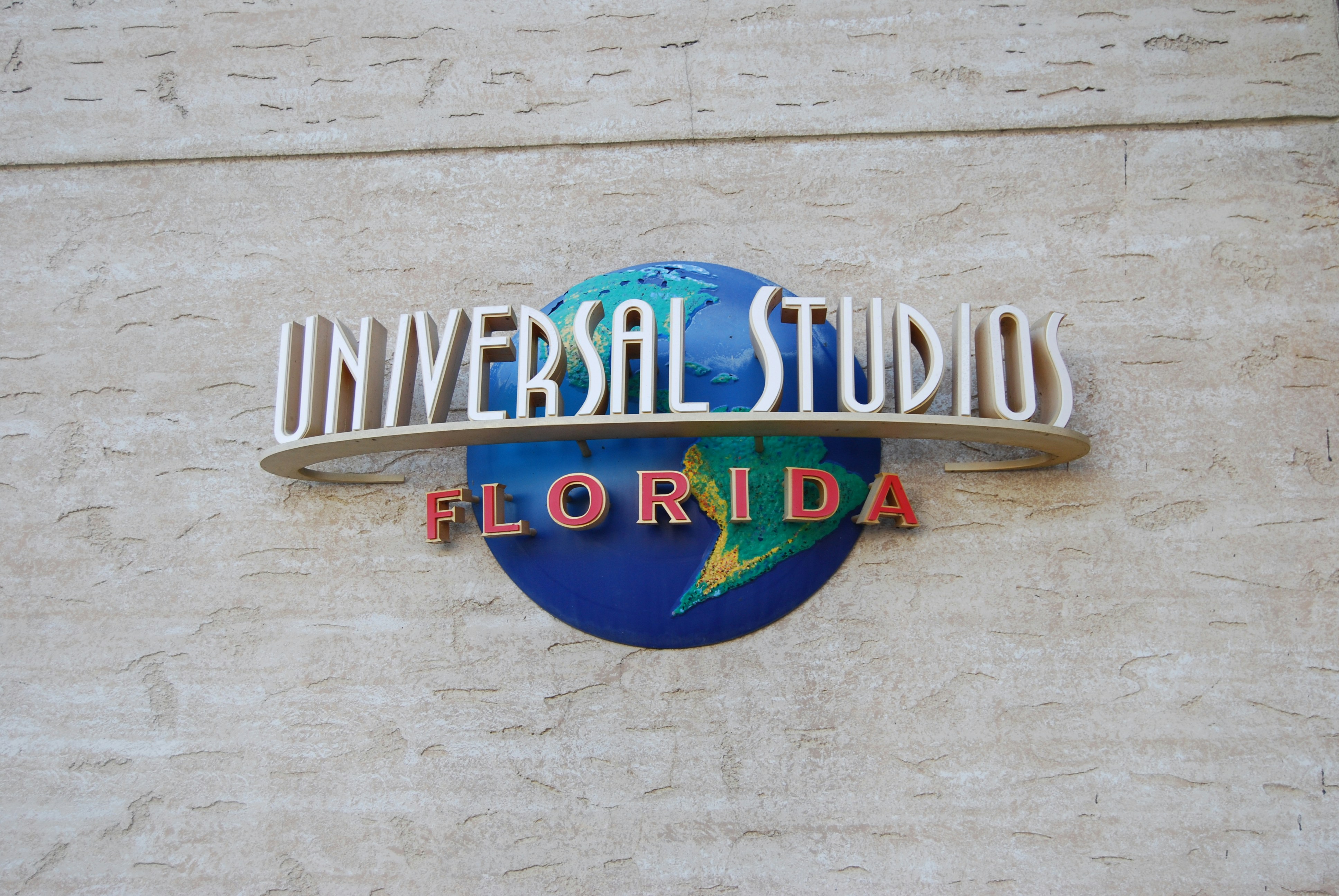 Universal Studios Florida logo on textured wall featuring a globe.
