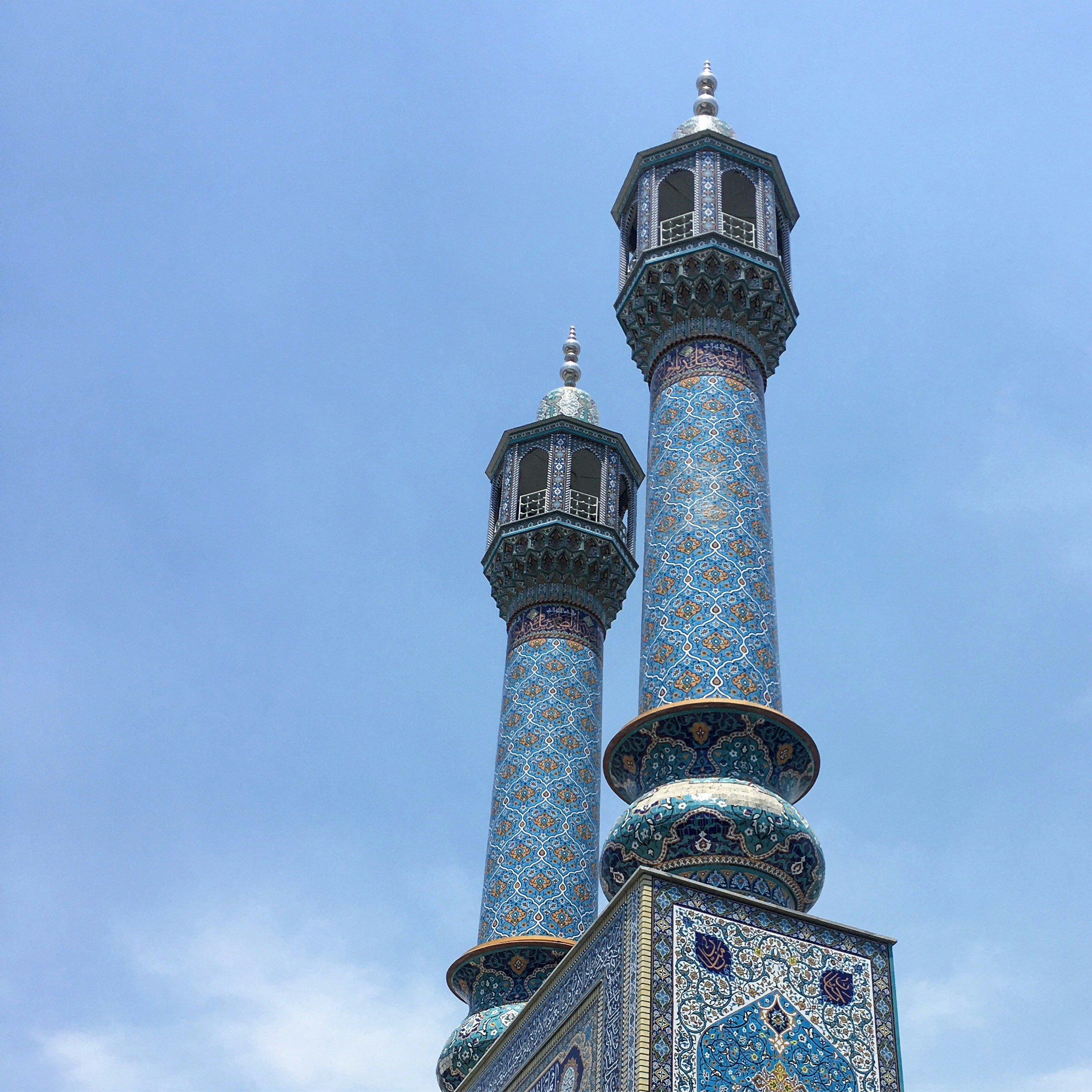 Twin Turquoise Minarets Rising Over a Cerulean Sky