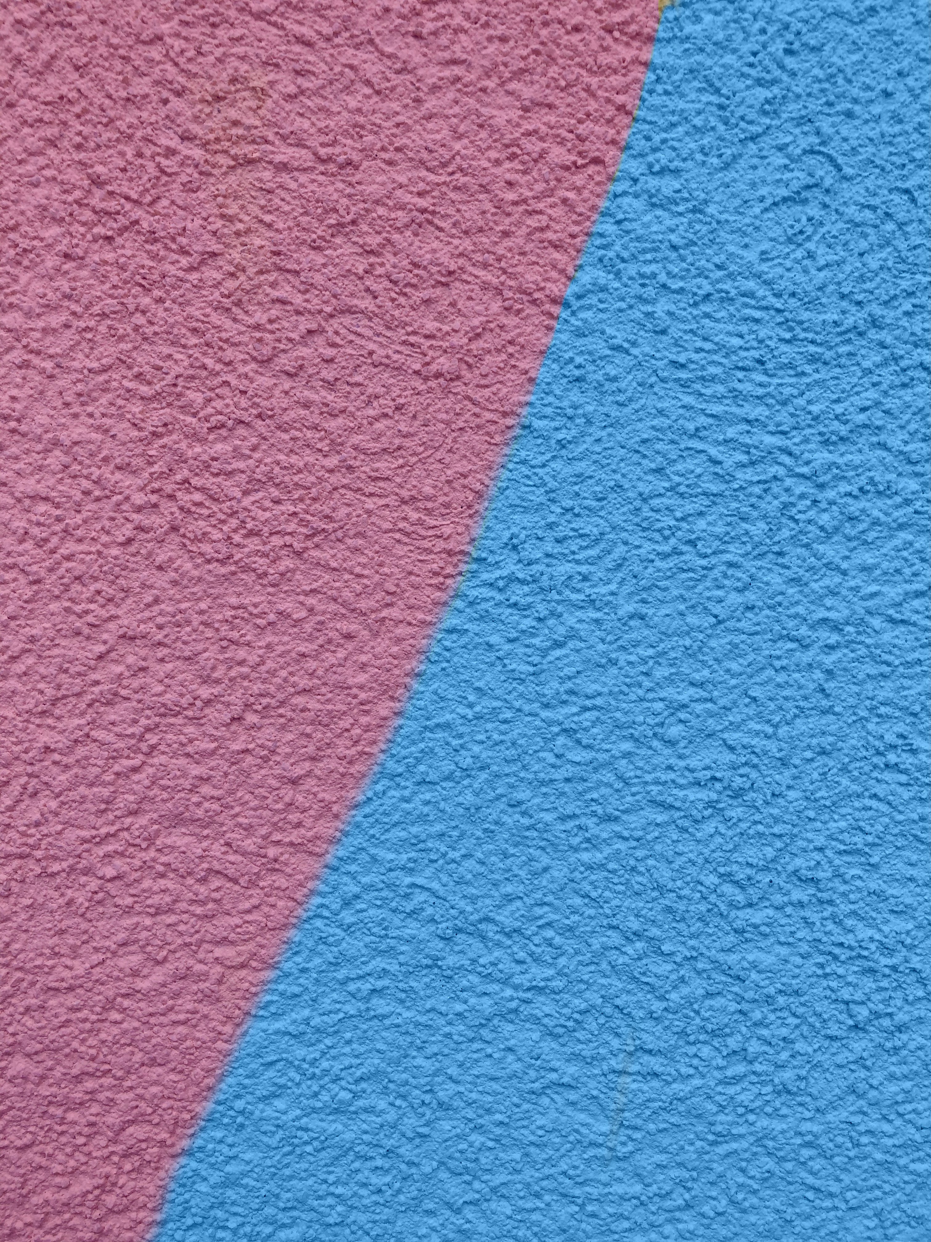 Two-Toned Curve: Pink and Blue Meet on a Textured Wall