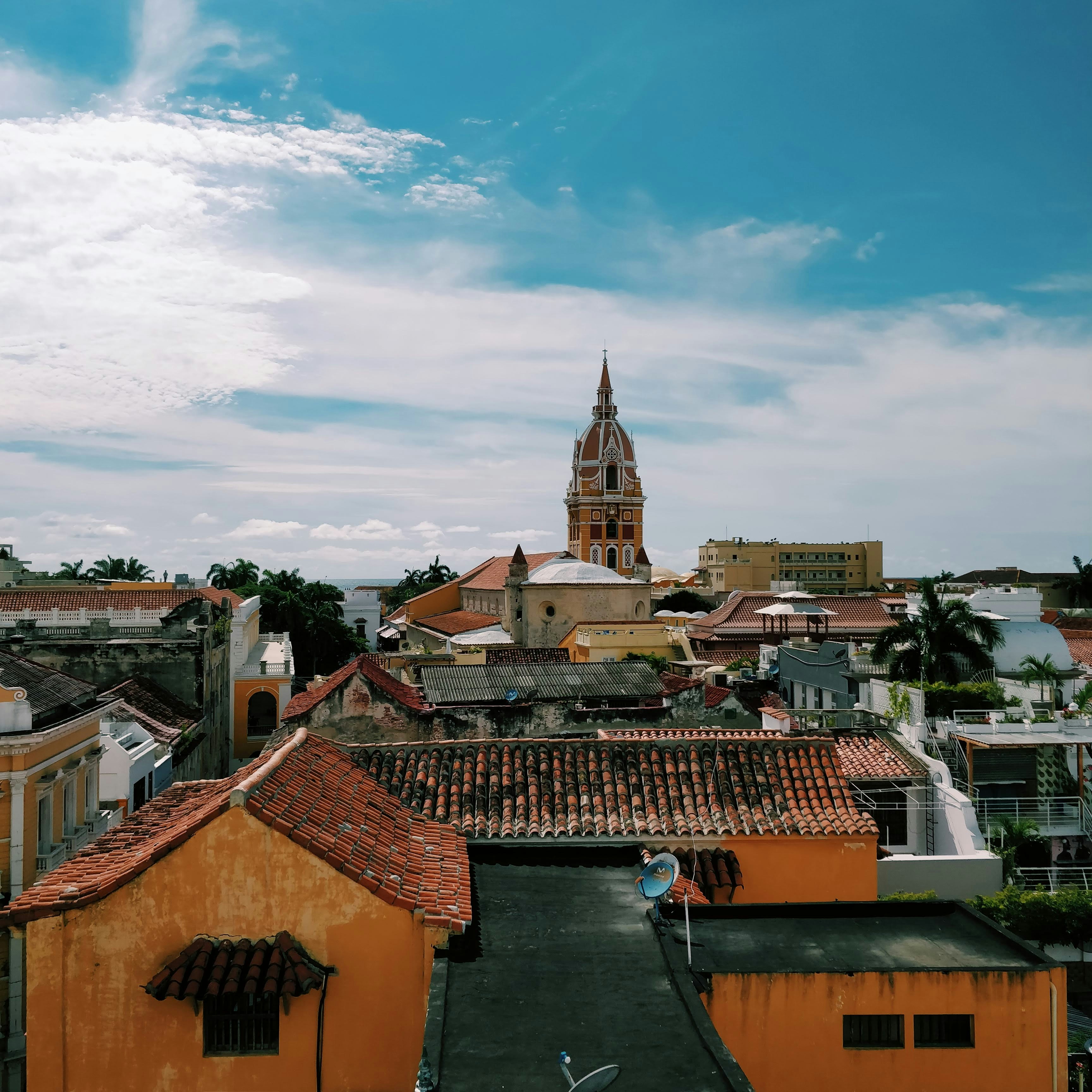 A day in Cartagena | brown and white concrete buildings under blue sky and white clouds during daytime