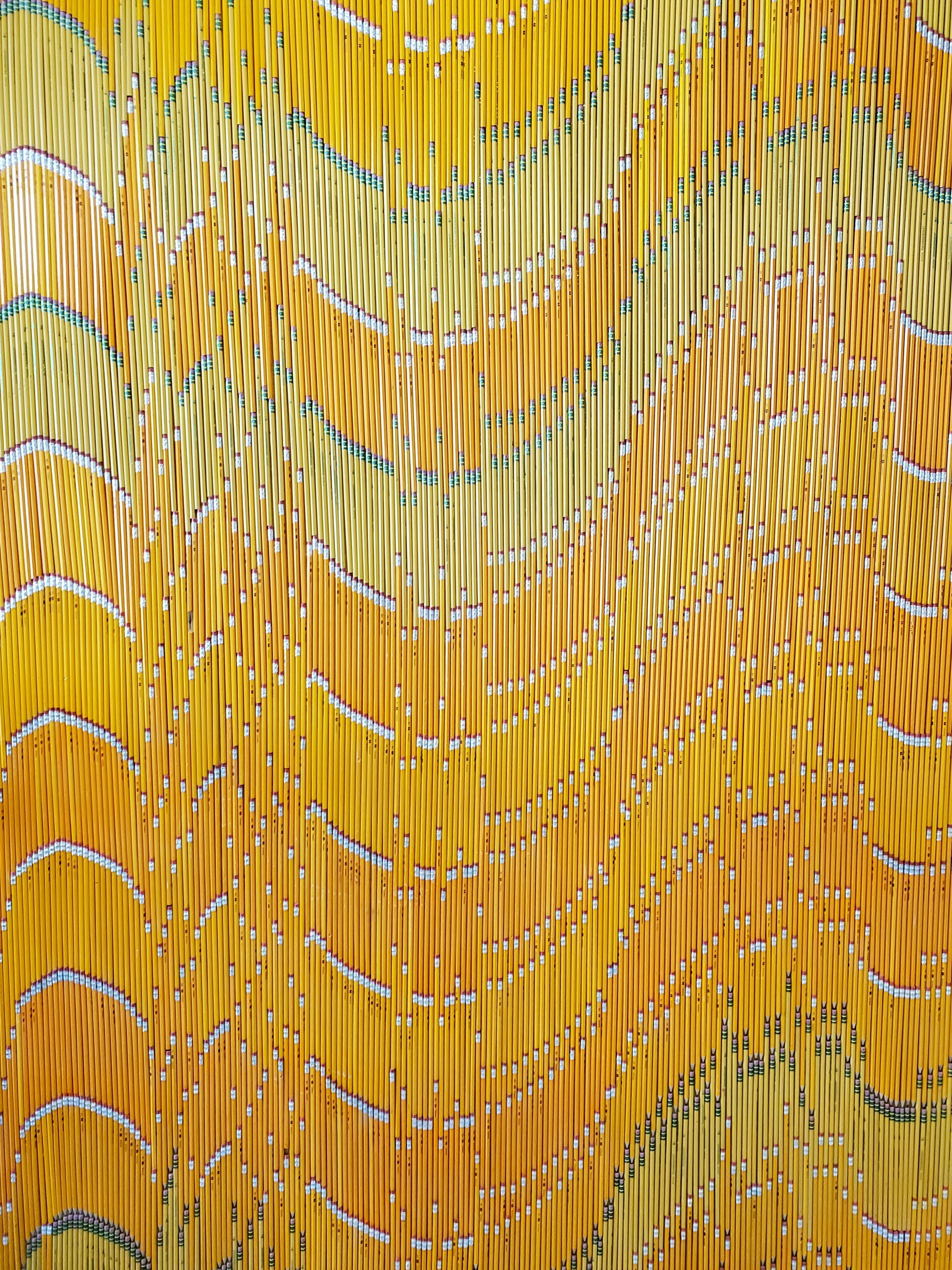 Abstract pattern of yellow and blue lines creating a rhythmic wave effect, showcasing a vibrant design. This illustration emphasizes movement and texture.