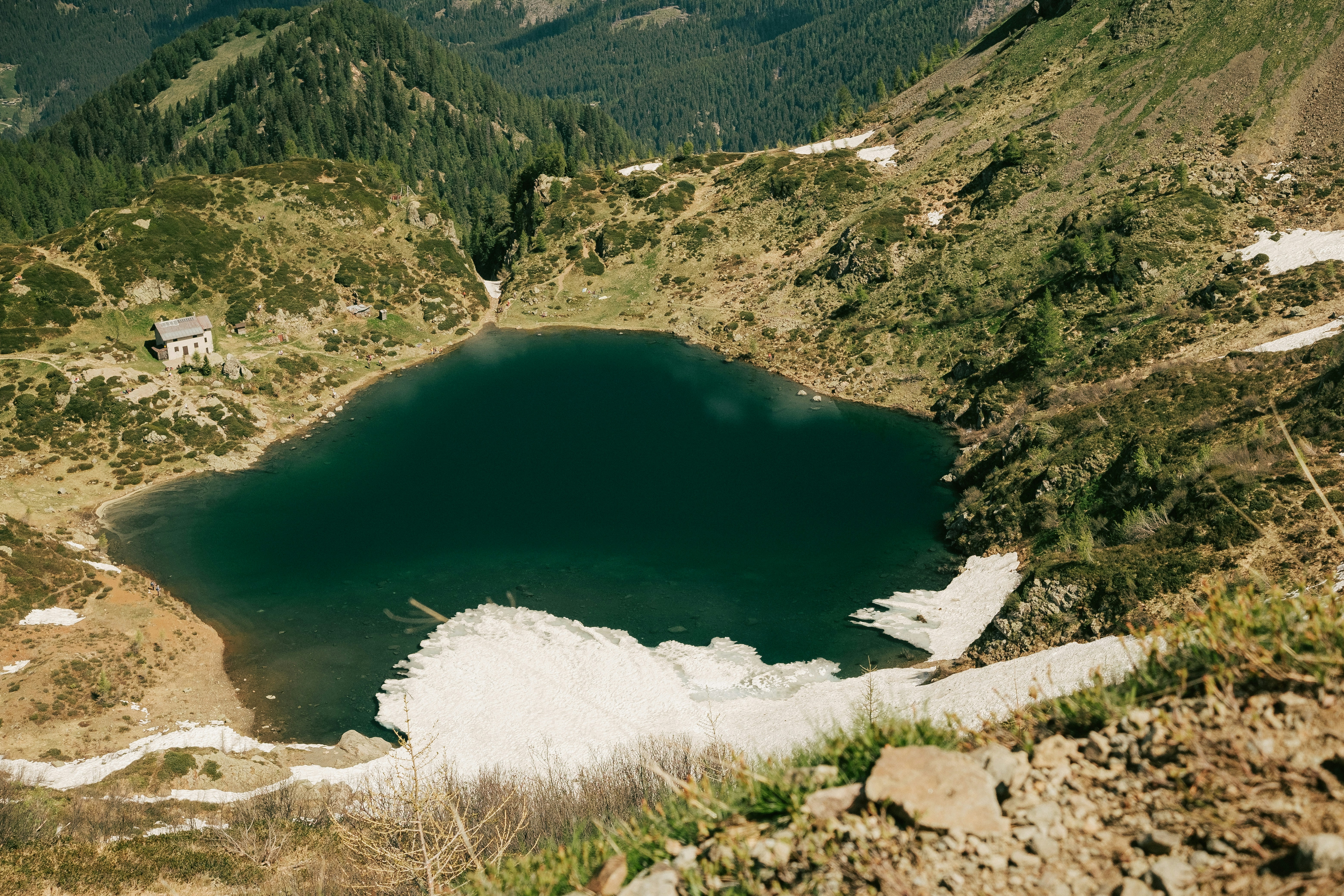 Emerald Crater Lake Between Stony Alpine Ridges