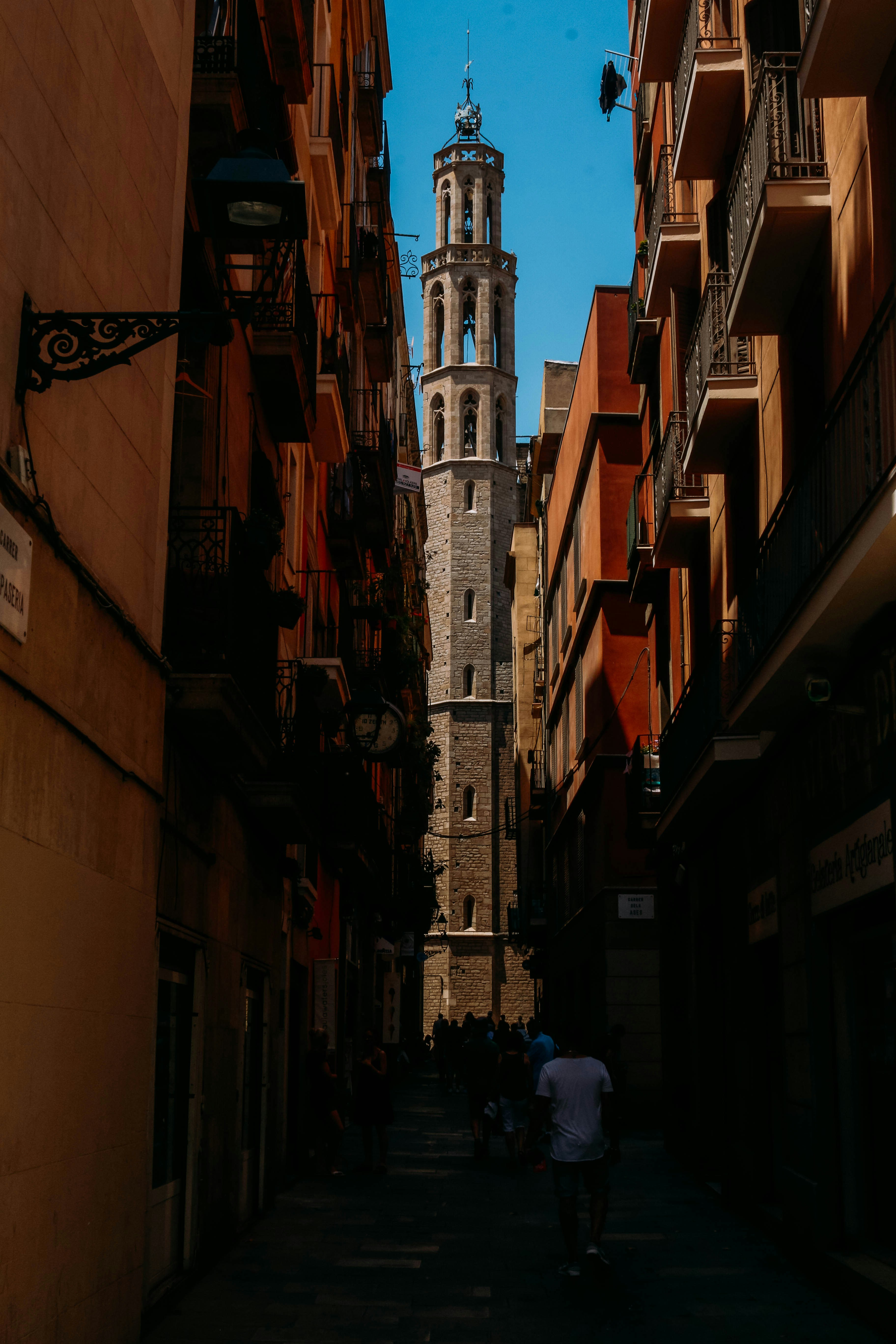 People walking on street between high rise buildings during daytime ...