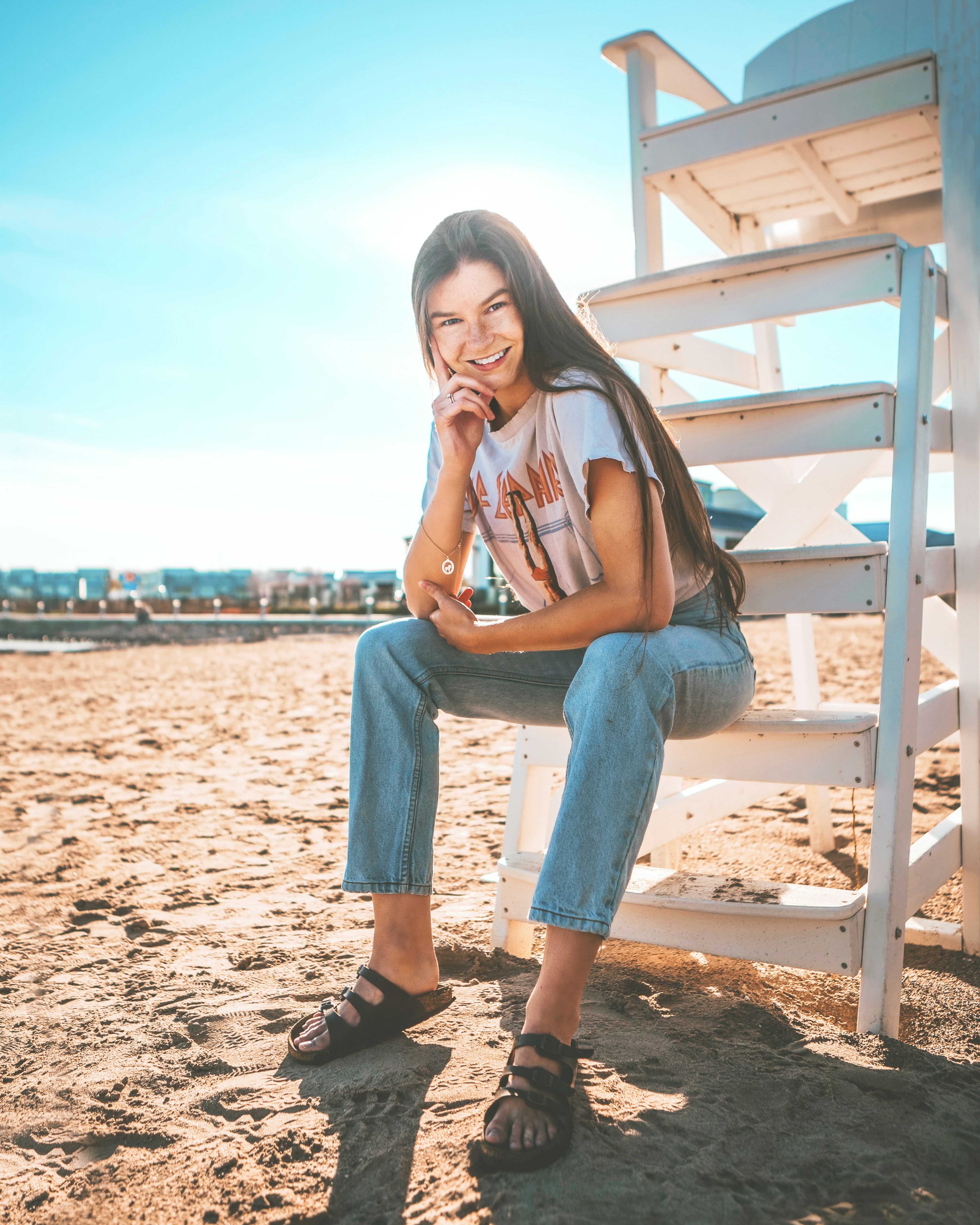 Sunlit Beach Portrait: A Casual Moment by the Lifeguard Chair
