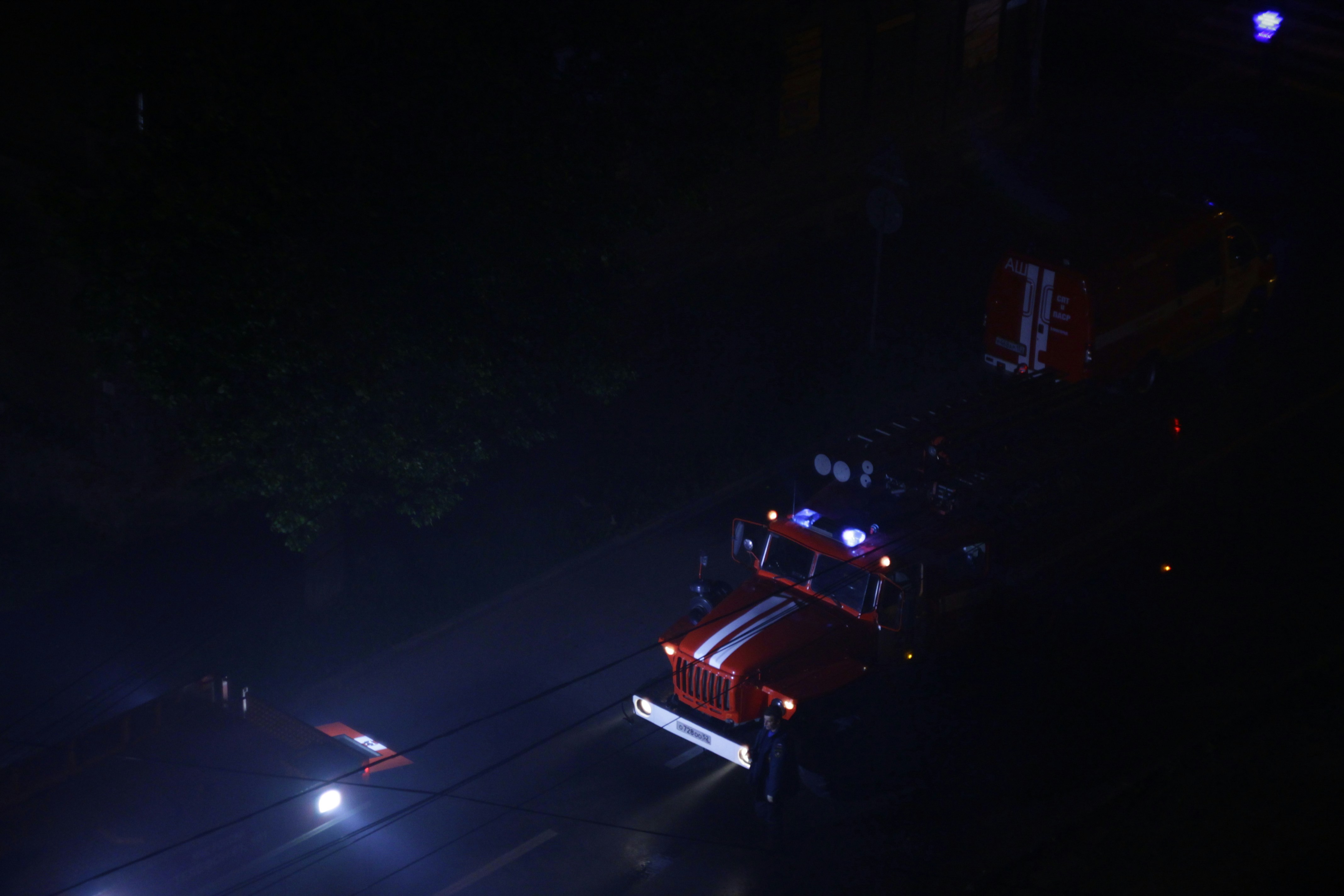 Night Run: A Crimson Fire Engine Under Blue Emergency Glare
