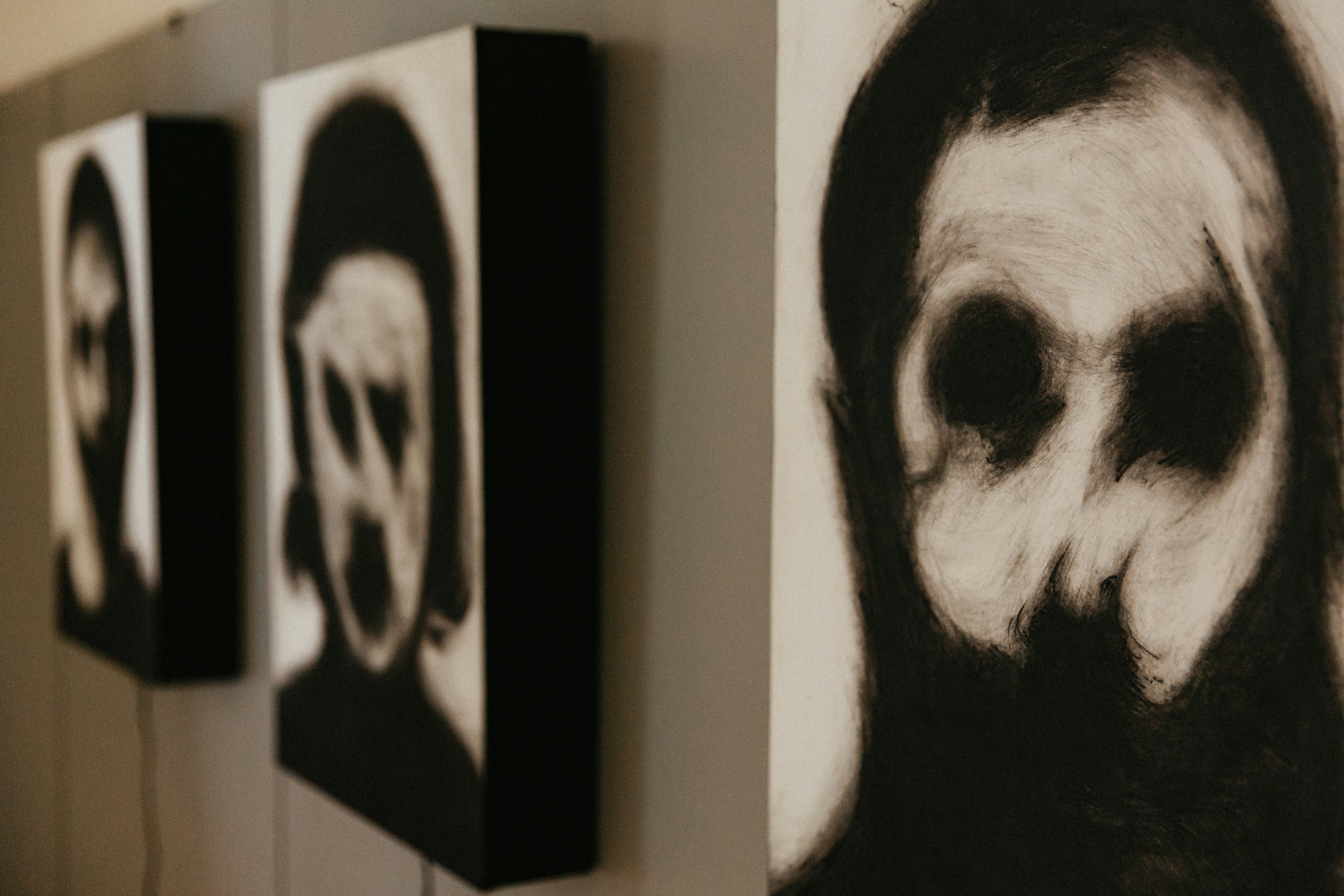 Monochrome Portrait Gallery: Three Faces in a Soft Corridor