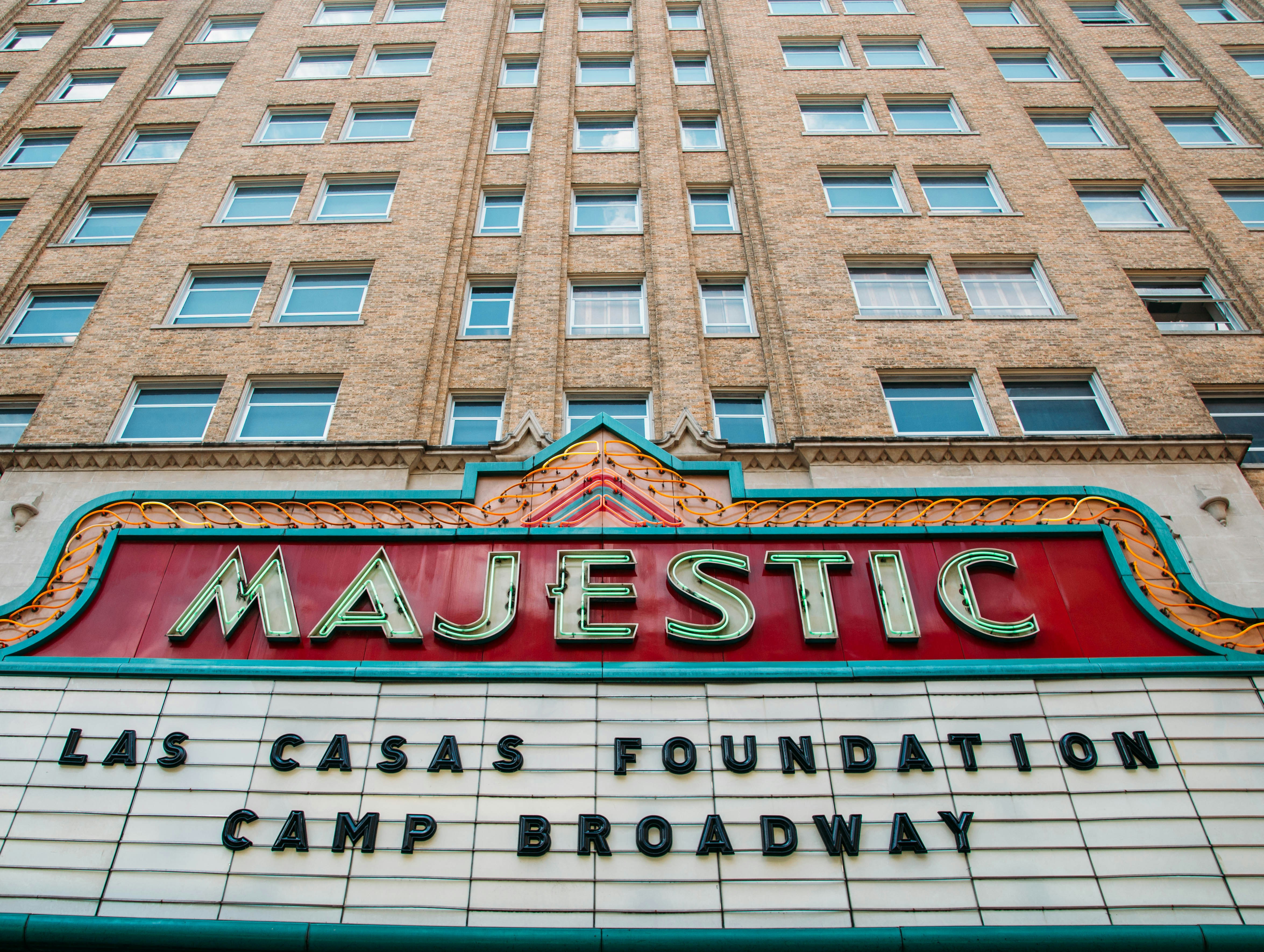 Historic theater marquee with intricate design against a backdrop of a brick building.