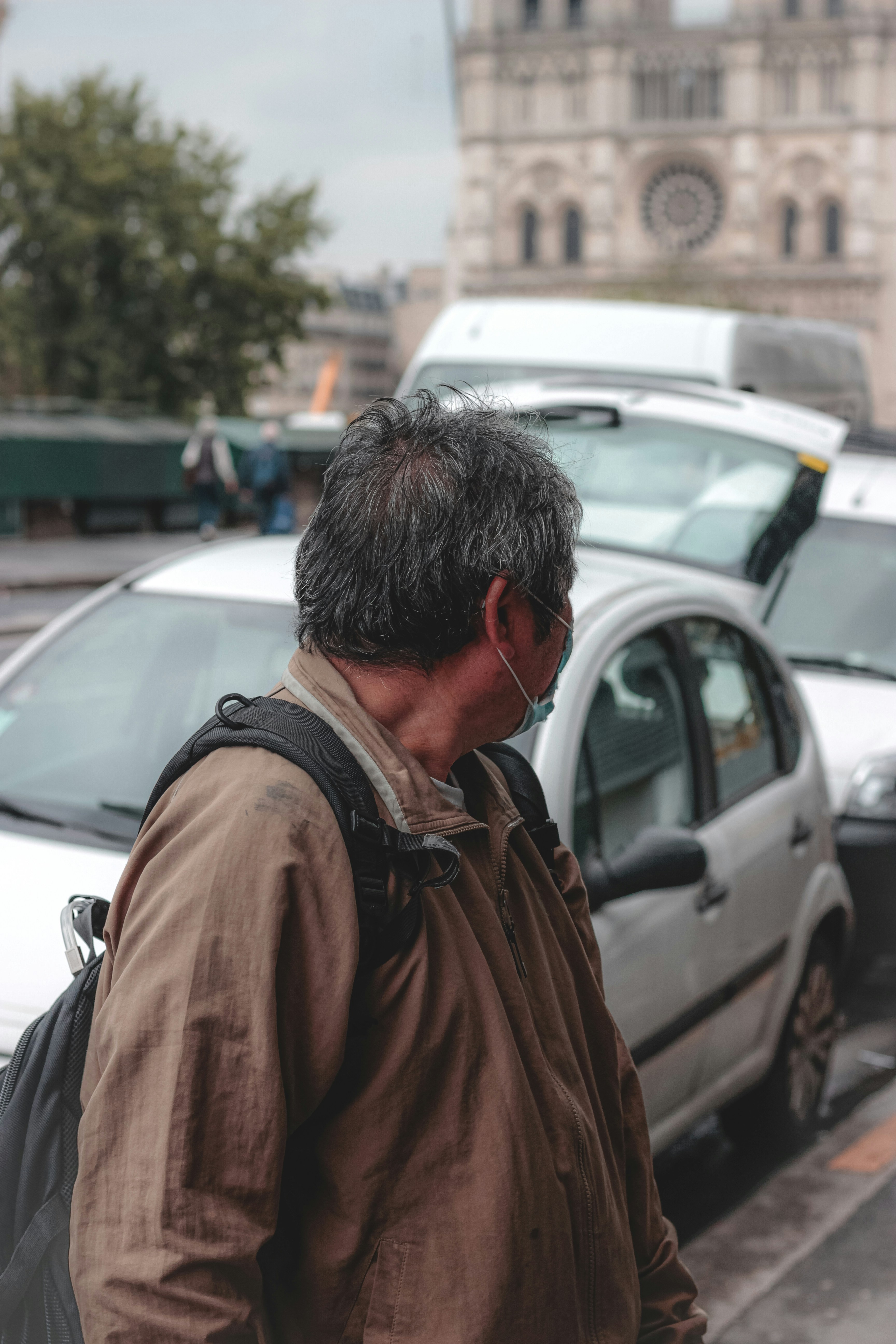 Man in brown jacket standing near cars during daytime photo – Free ...