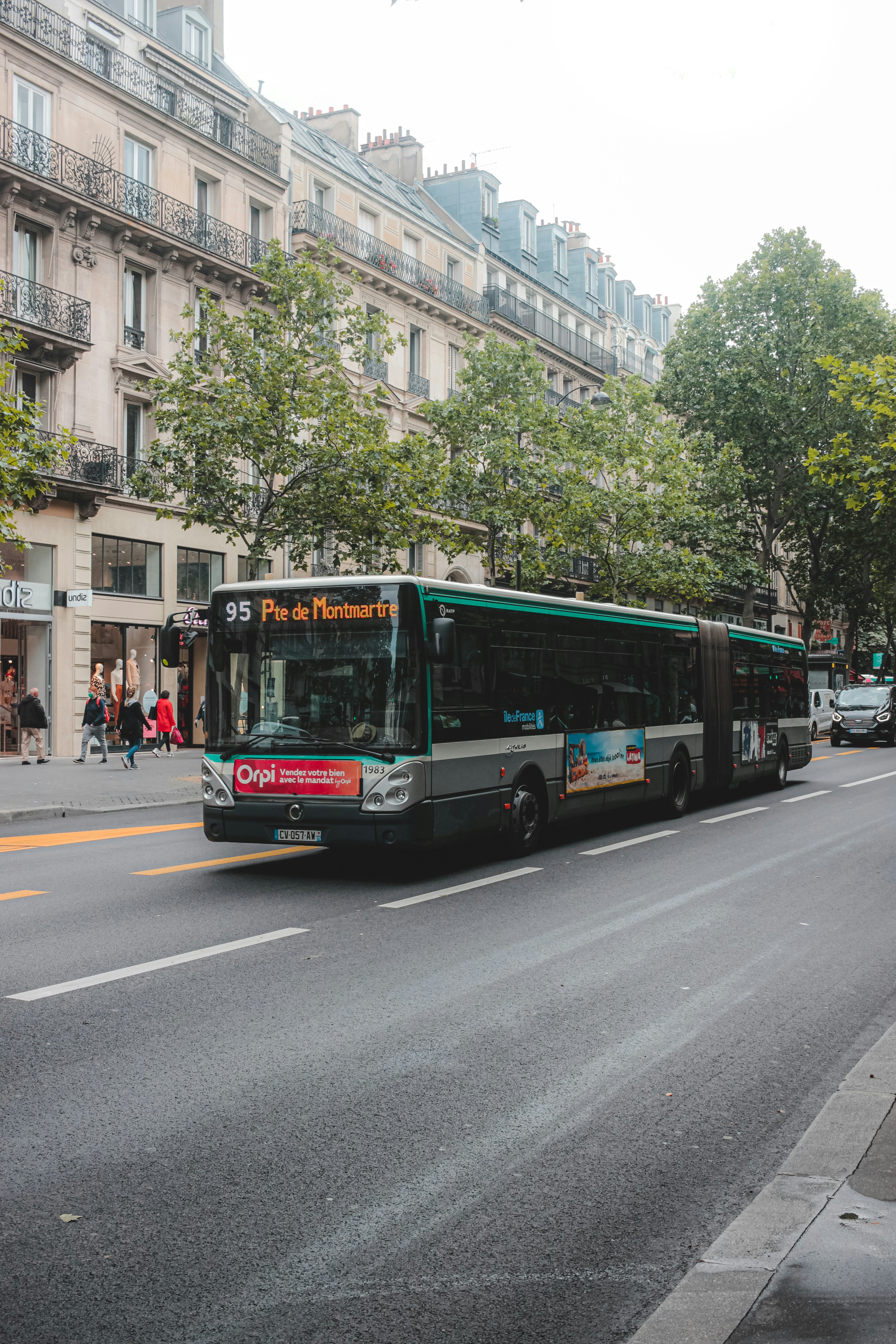 Urban Bus in Motion Along a Parisian Street
